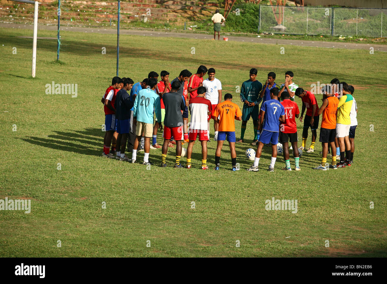 Group of youngsters circled around and ready to play football Stock ...