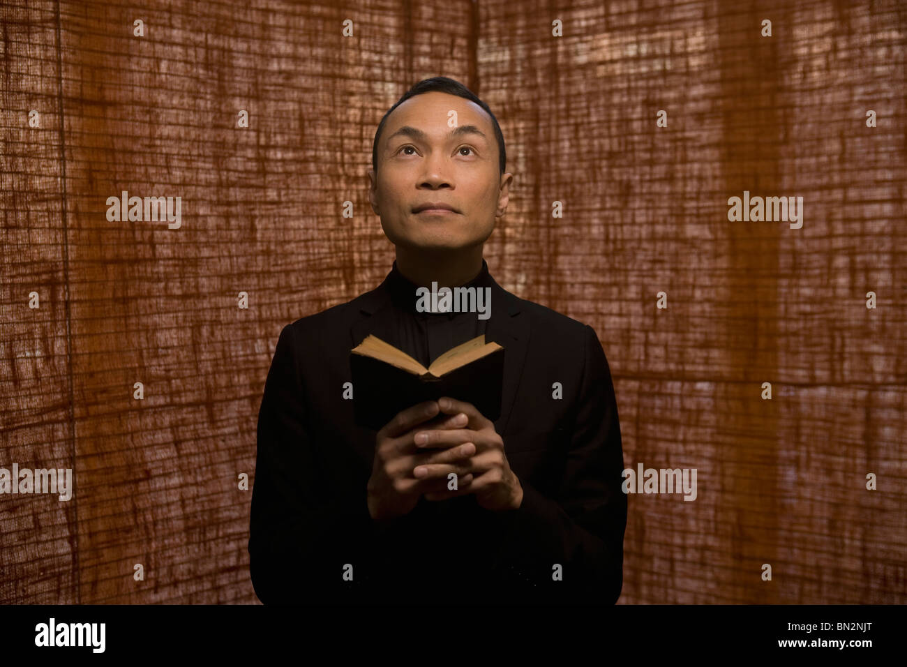 Pacific Islander priest praying Stock Photo - Alamy