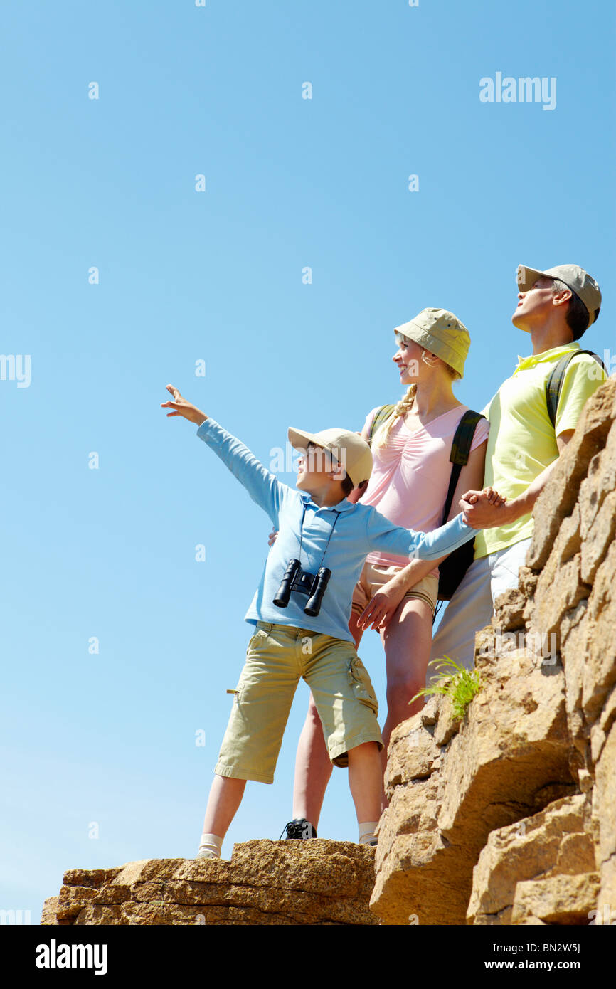 Portrait of family members looking afar while standing on cliff Stock ...