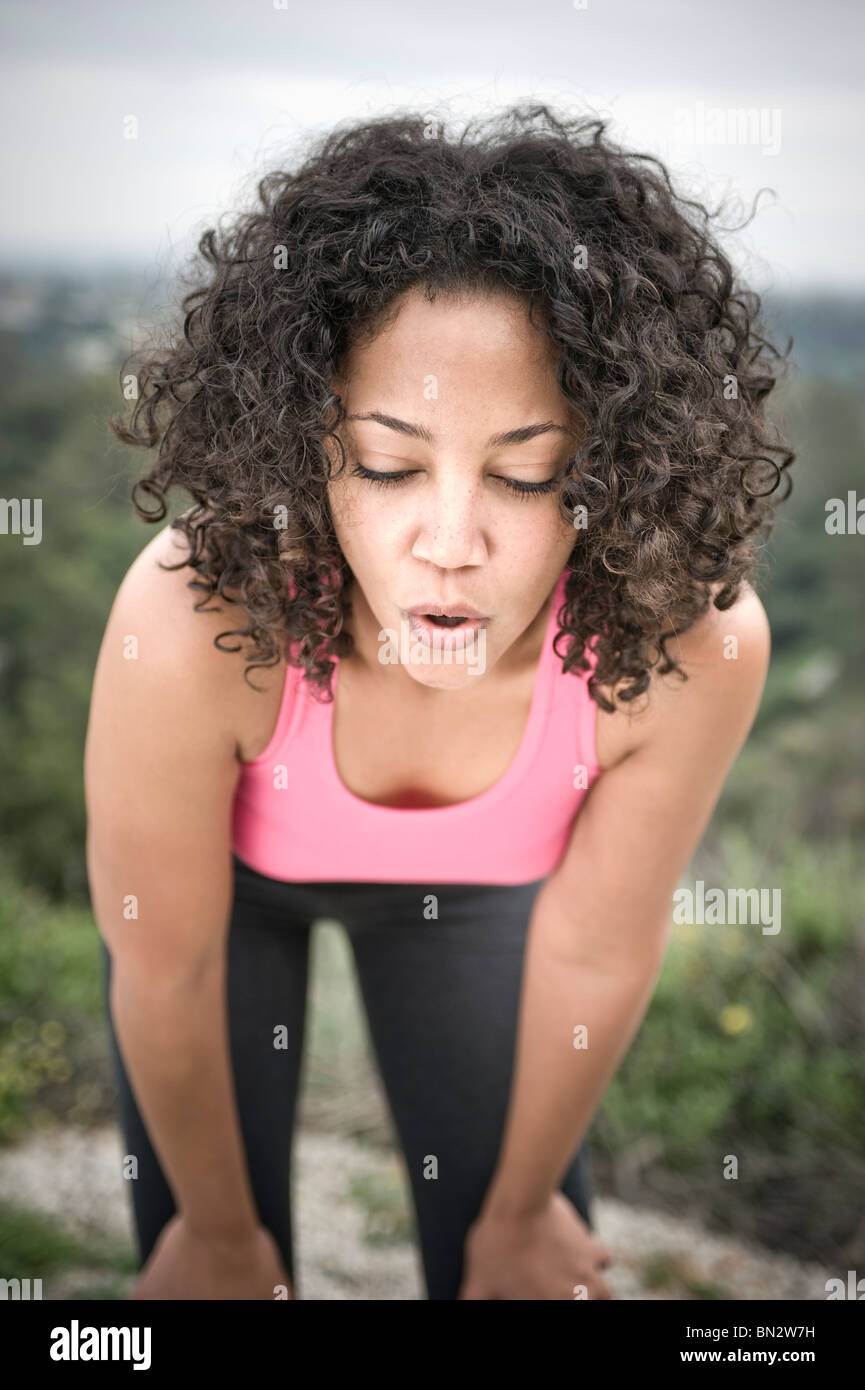 Tired woman resting after exercise Stock Photo - Alamy