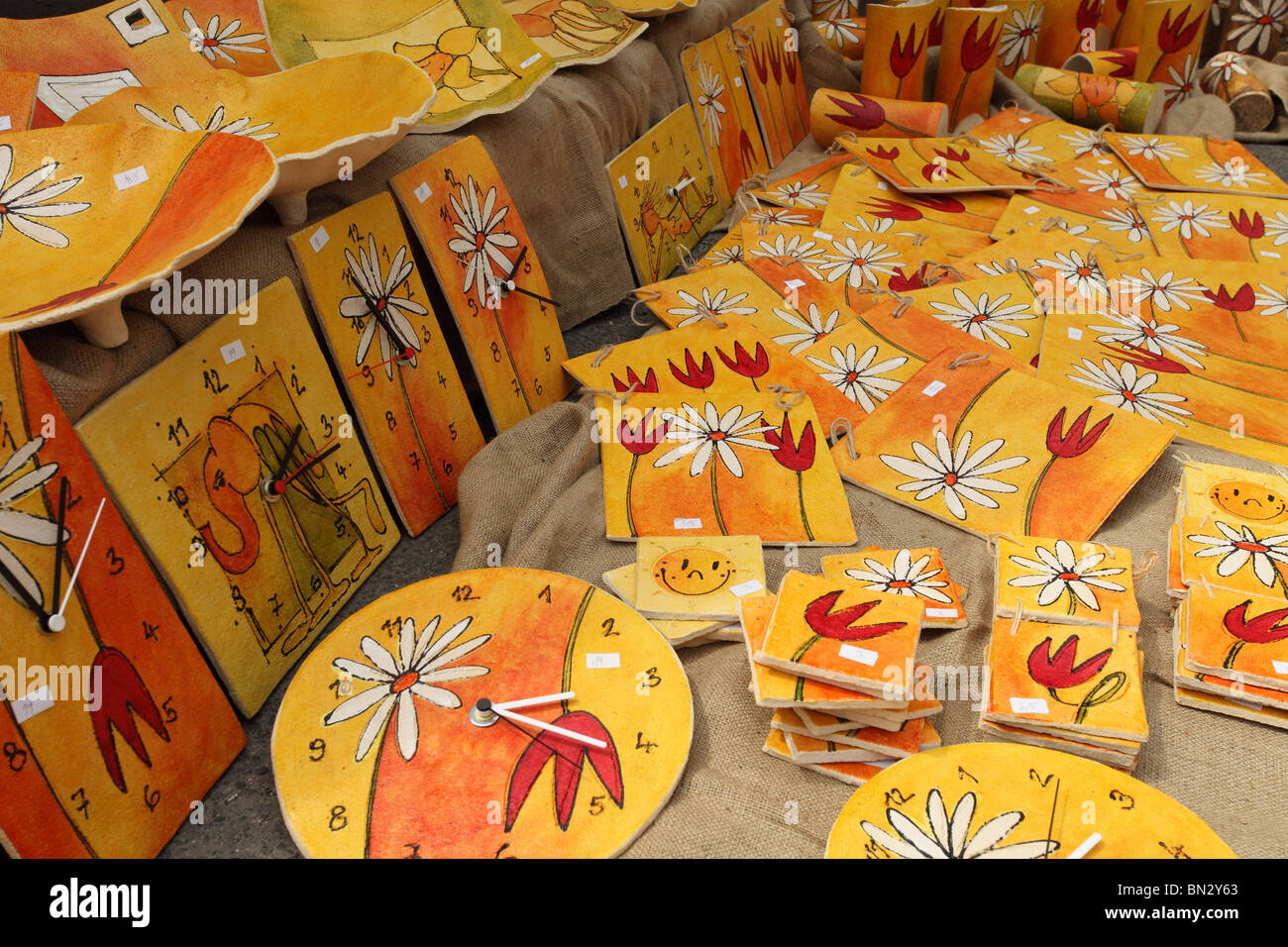 Clay products with flower design on display at the pottery craft fair ...