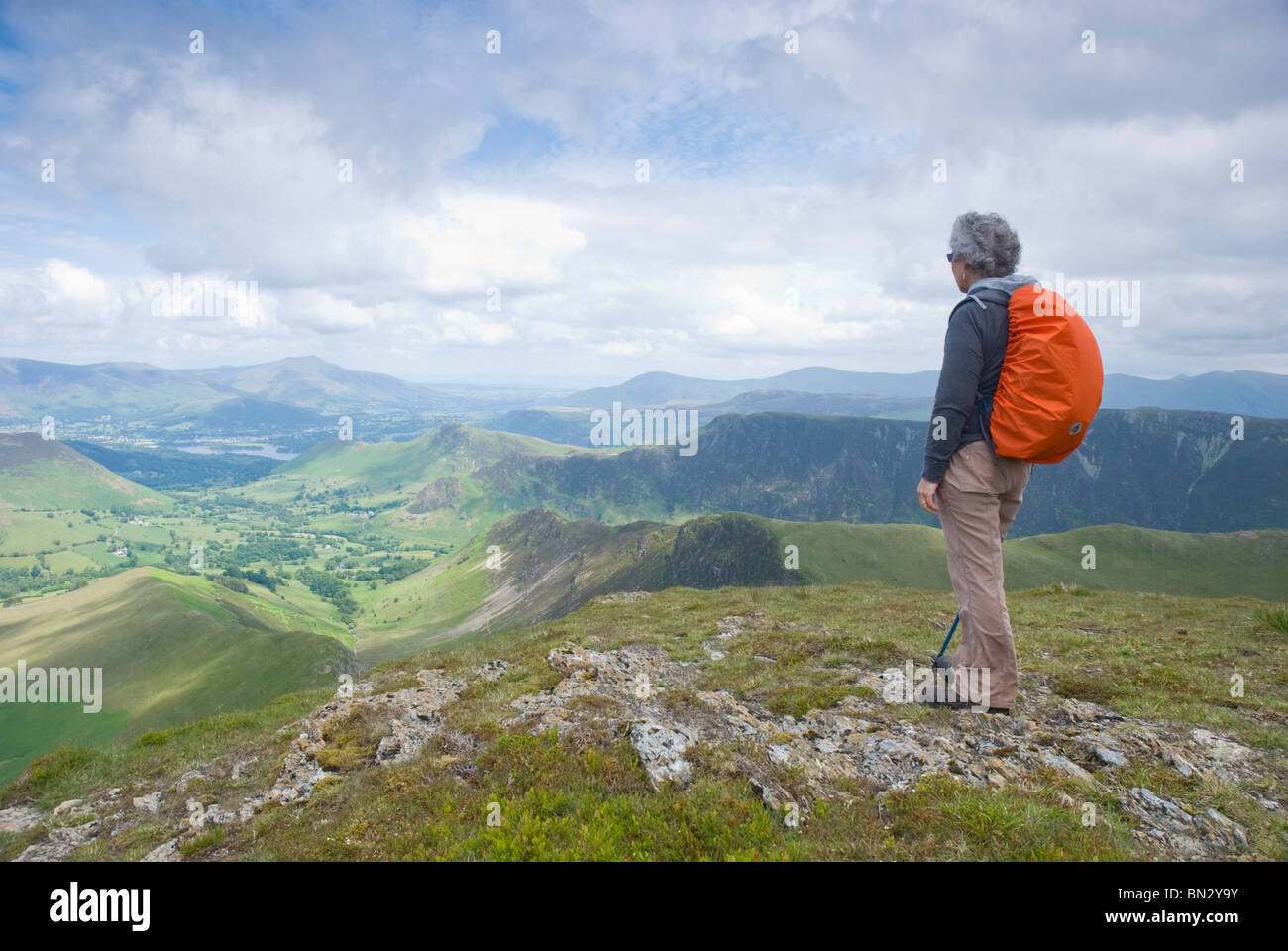 Lady fell walker looking at the view from the Lake District fell of ...
