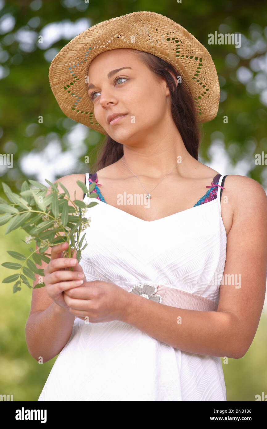 Portrait Of Thoughtful Attractive Young Woman Wearing Straw Hat Stock