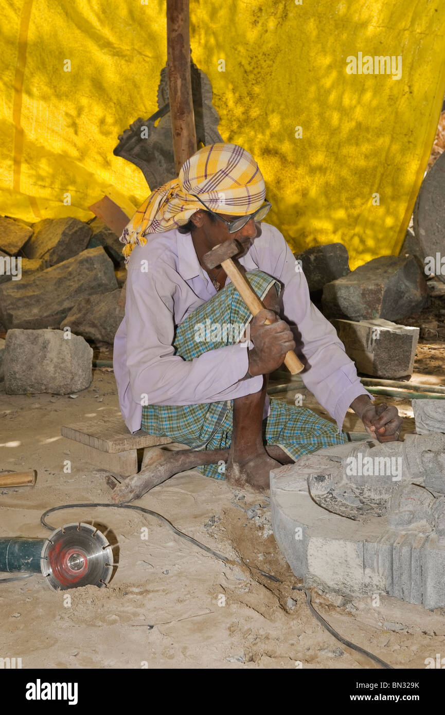 India Tamil Nadu Mamallapuram an Indian craftsman carving a stone ...