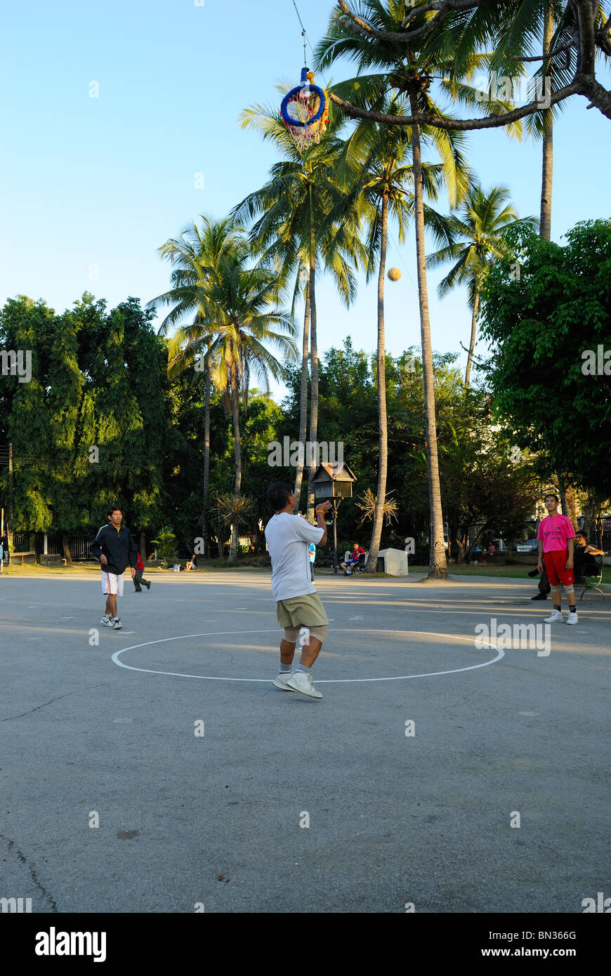 Thai men playing rattan ball game (Takraw) on a public place in Chiang ...