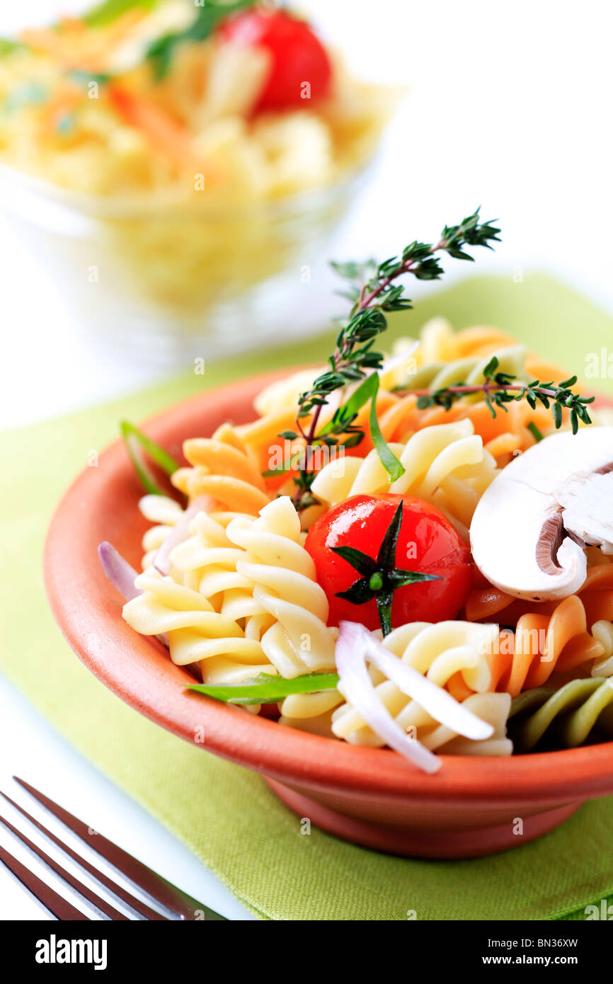 Tricolor corkscrew pasta in a terracotta bowl Stock Photo - Alamy