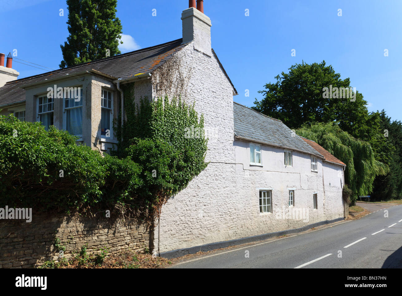 Attractive Stone, white painted farmhouse on the road through the ...