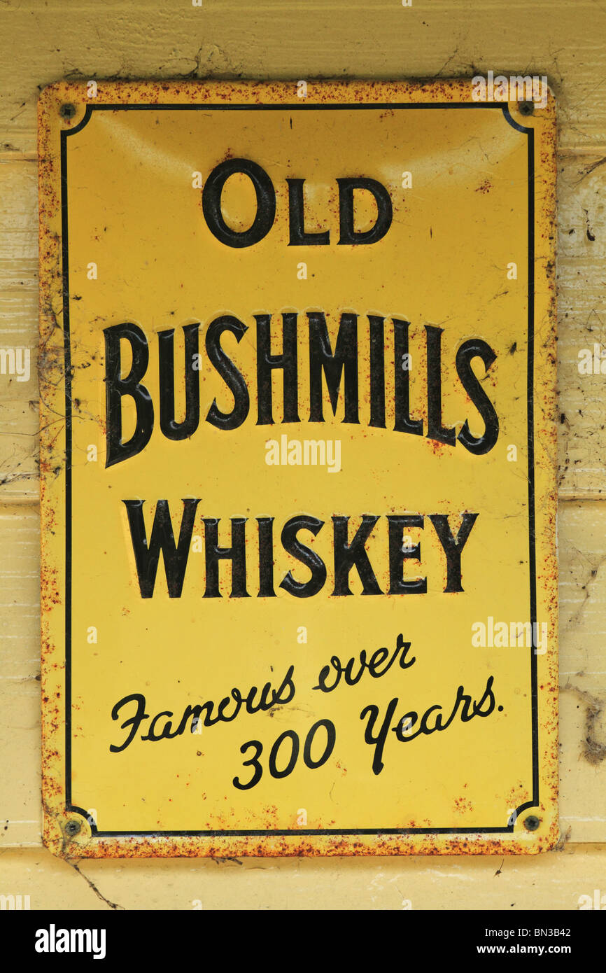 An old Bushmills Whiskey Sign on the external wall of a Pub in County ...