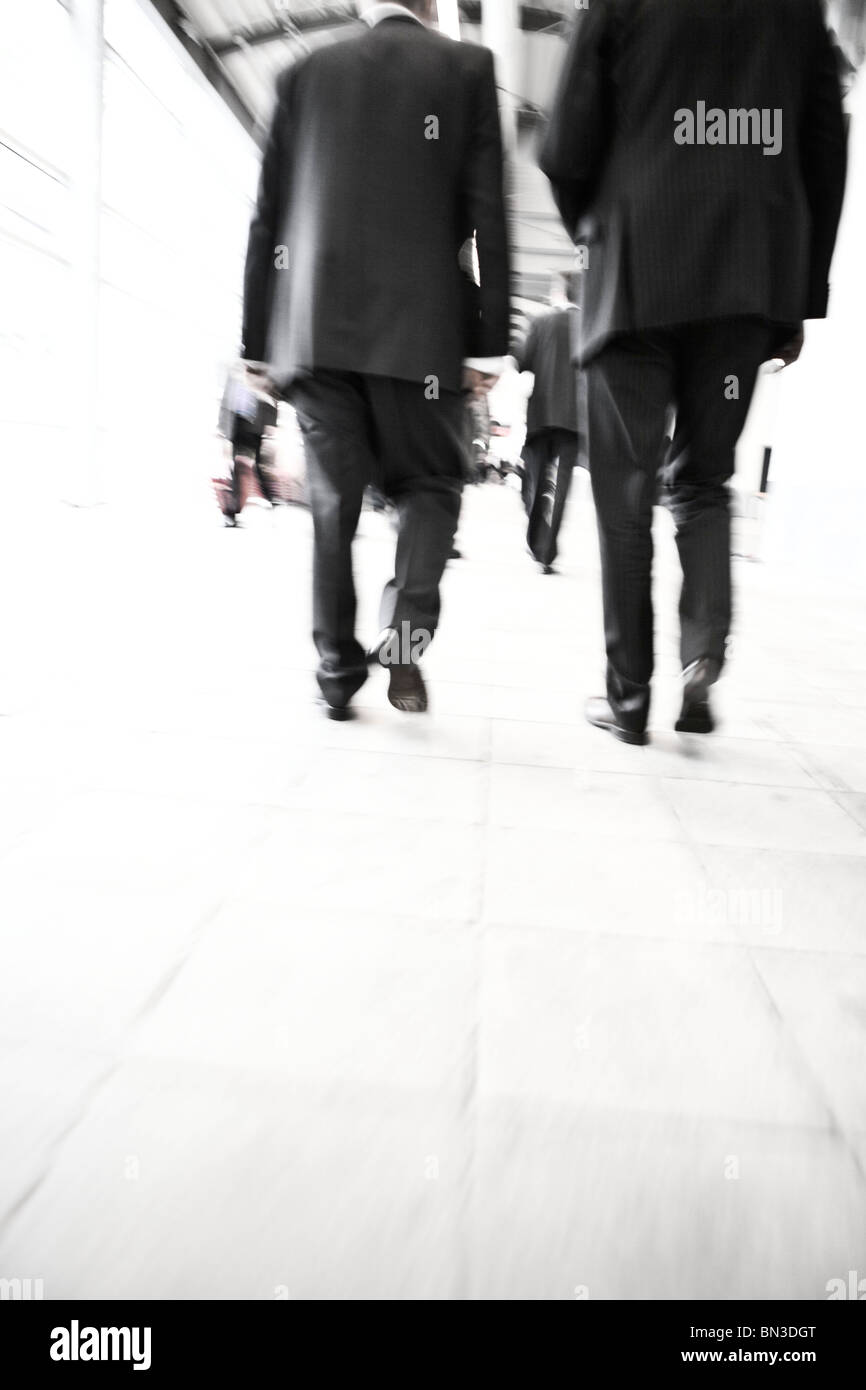 Businessmen walking on a pavement, low angle view Stock Photo - Alamy