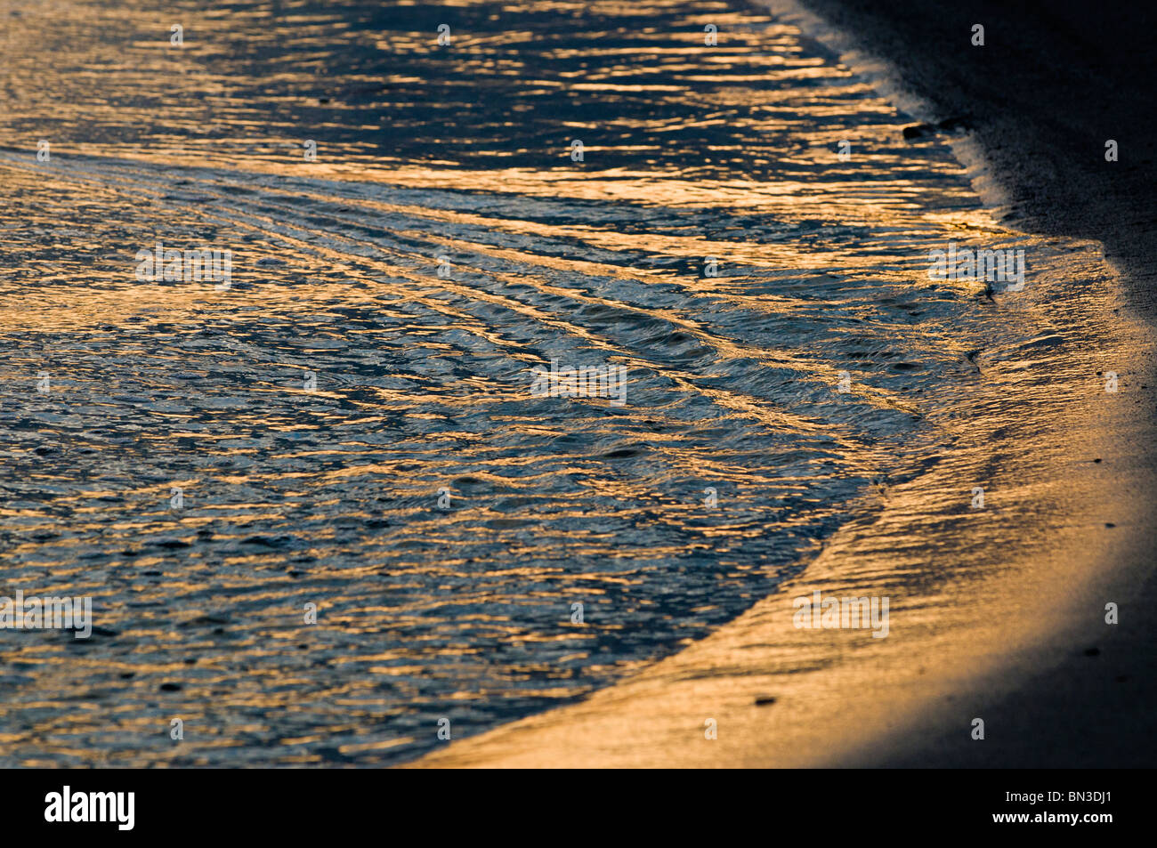 Sunset reflects on incoming tide at Sandspur Beach, Bahia Honda State ...