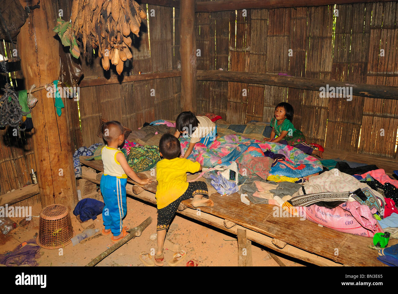 Kids playing on a bed Inside a house of a Hmong village, Mae Hong Son ...