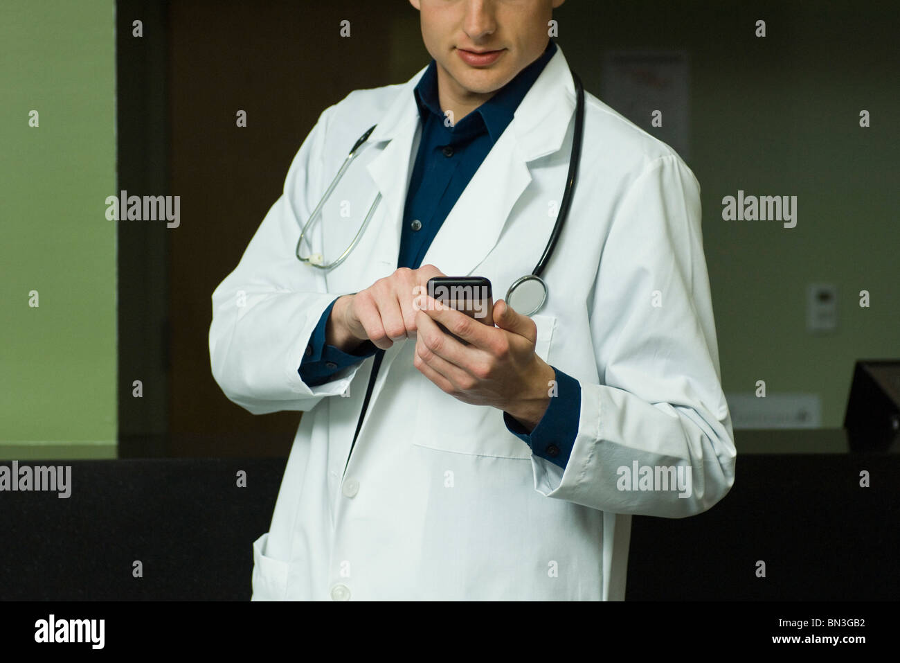 Male doctor text messaging Stock Photo - Alamy