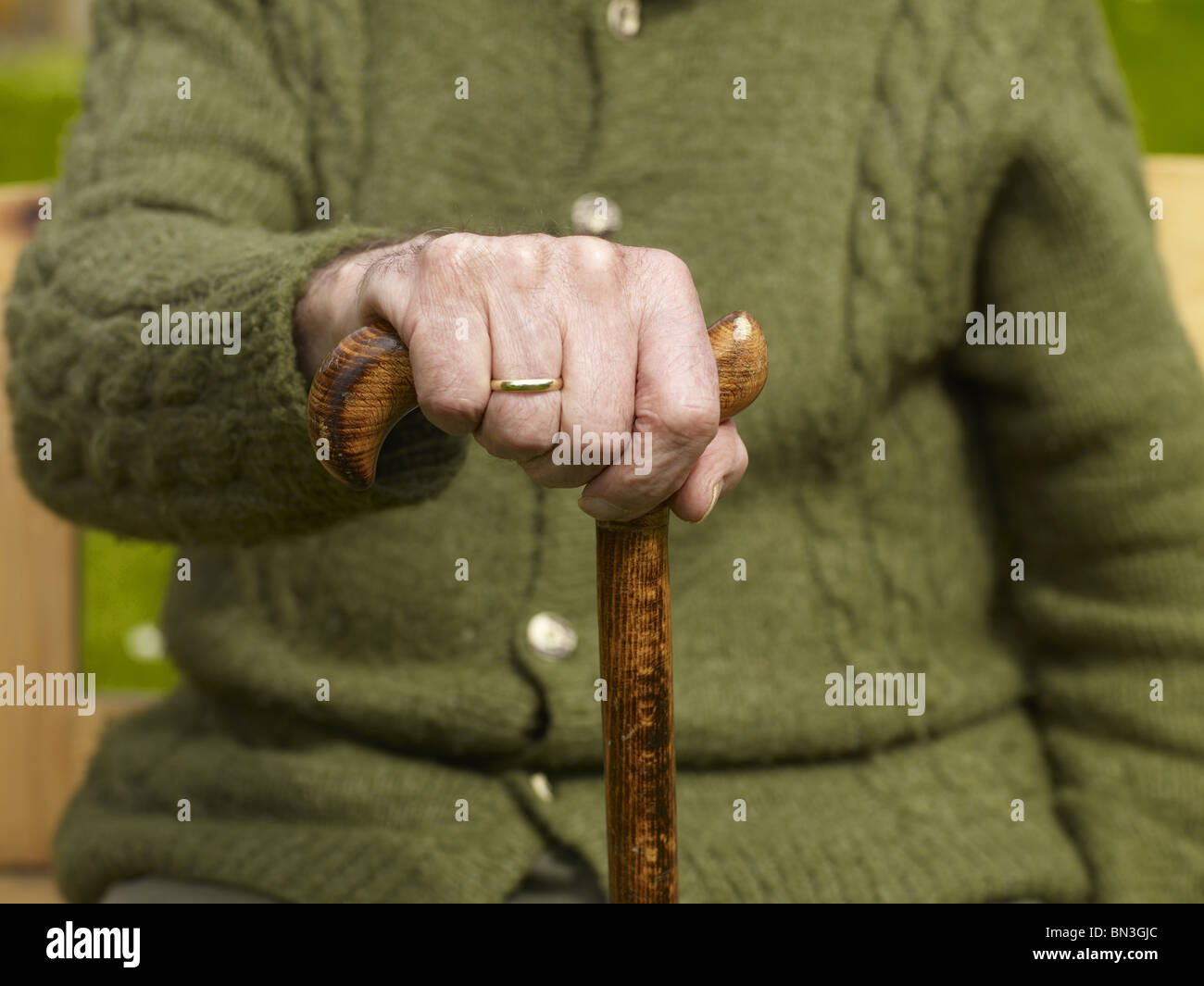 Senior man holding hand on cane, close-up Stock Photo - Alamy