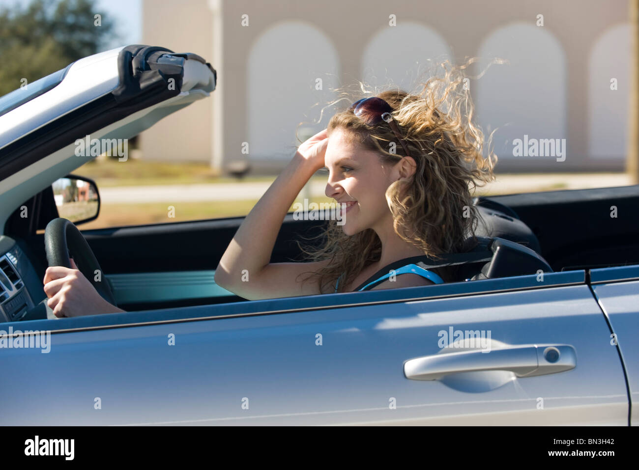 Young woman driving convertible Stock Photo - Alamy