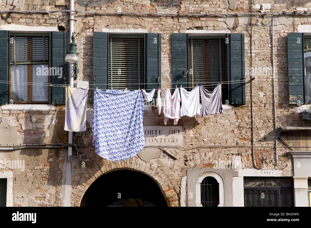 Laundry drying on a house facade, Venice, Italy Stock Photo - Alamy