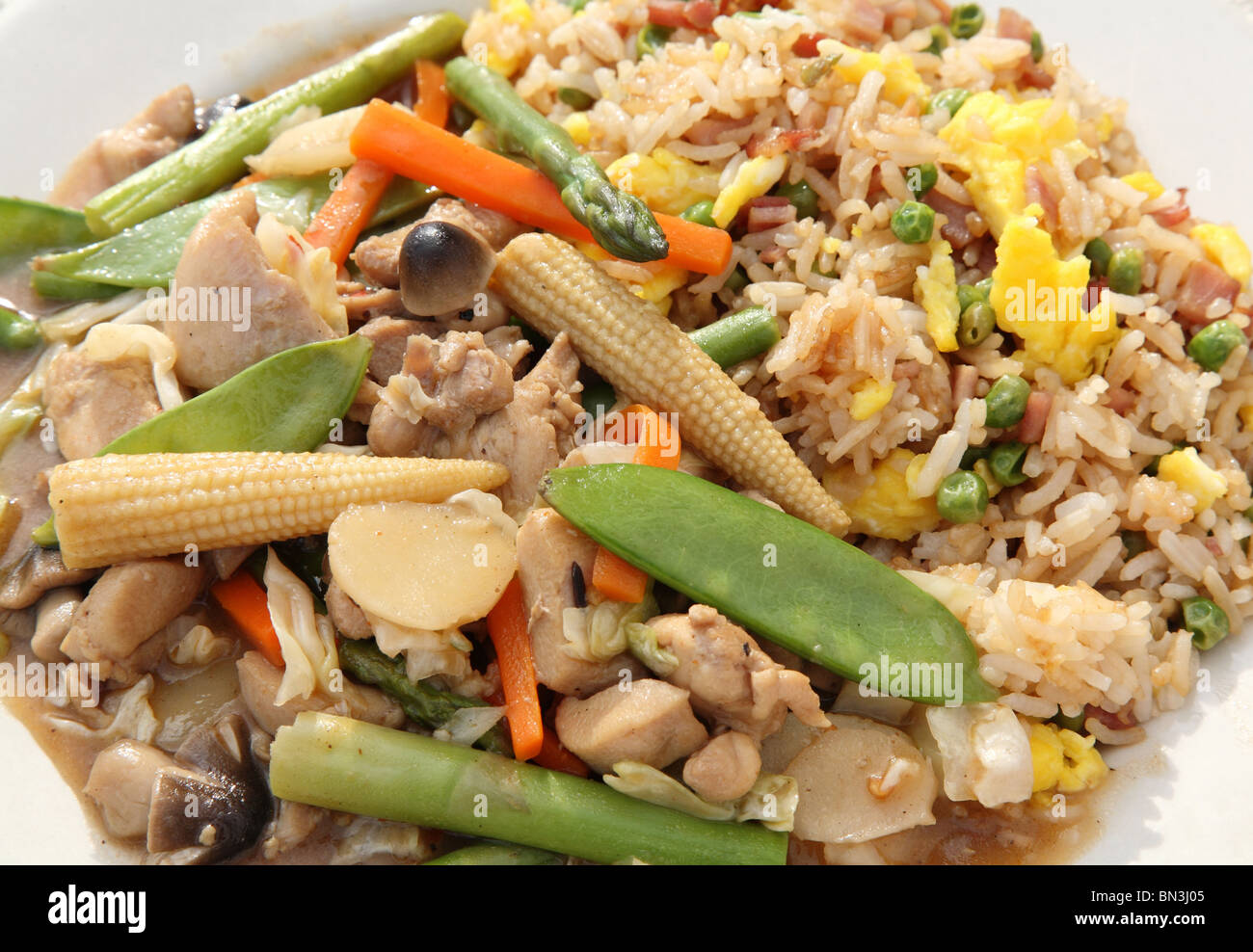 chinese chicken and vegetable stir fry meal served with ham fried rice ...