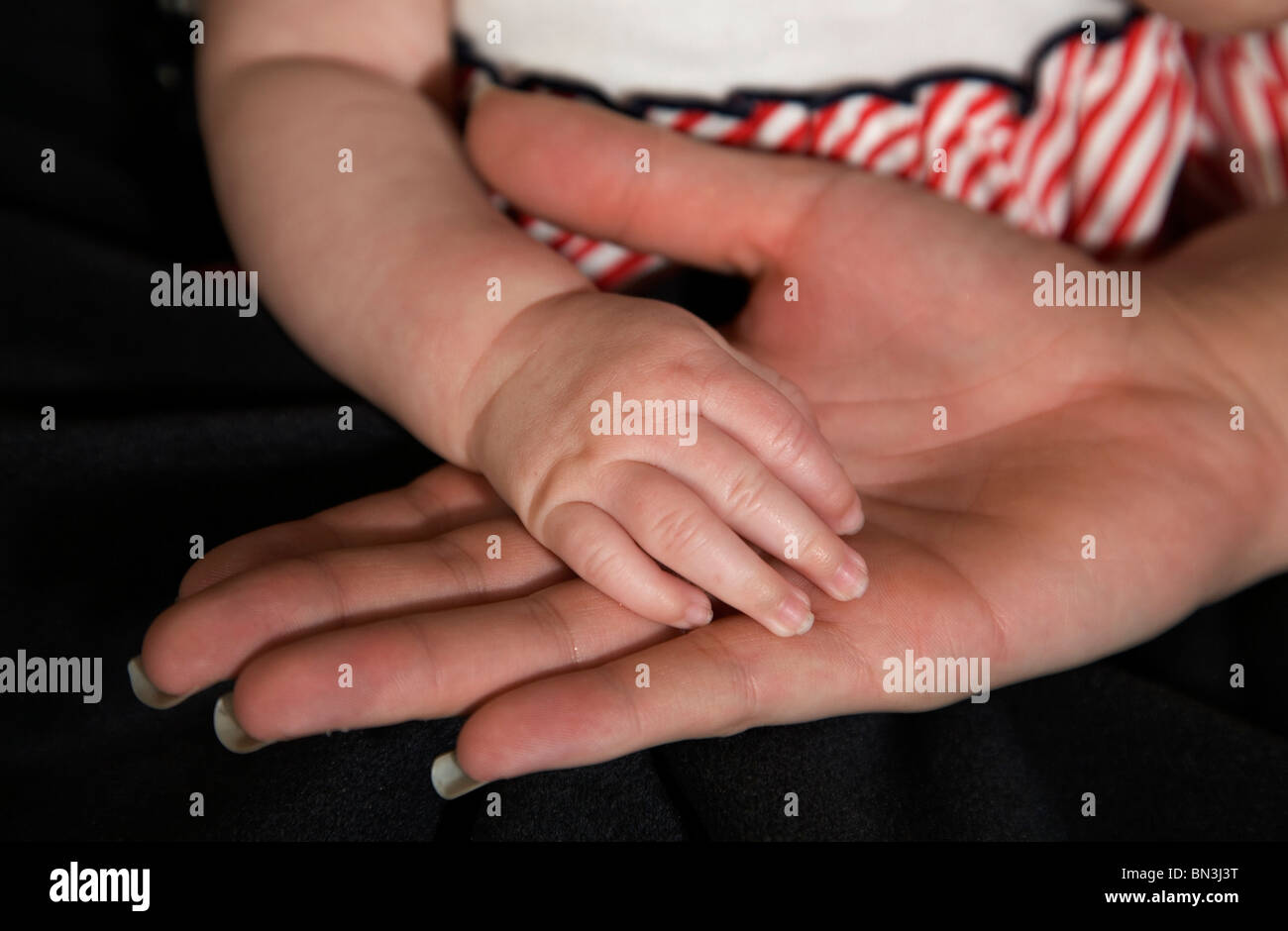 A baby's hand in her mother's hand Stock Photo - Alamy