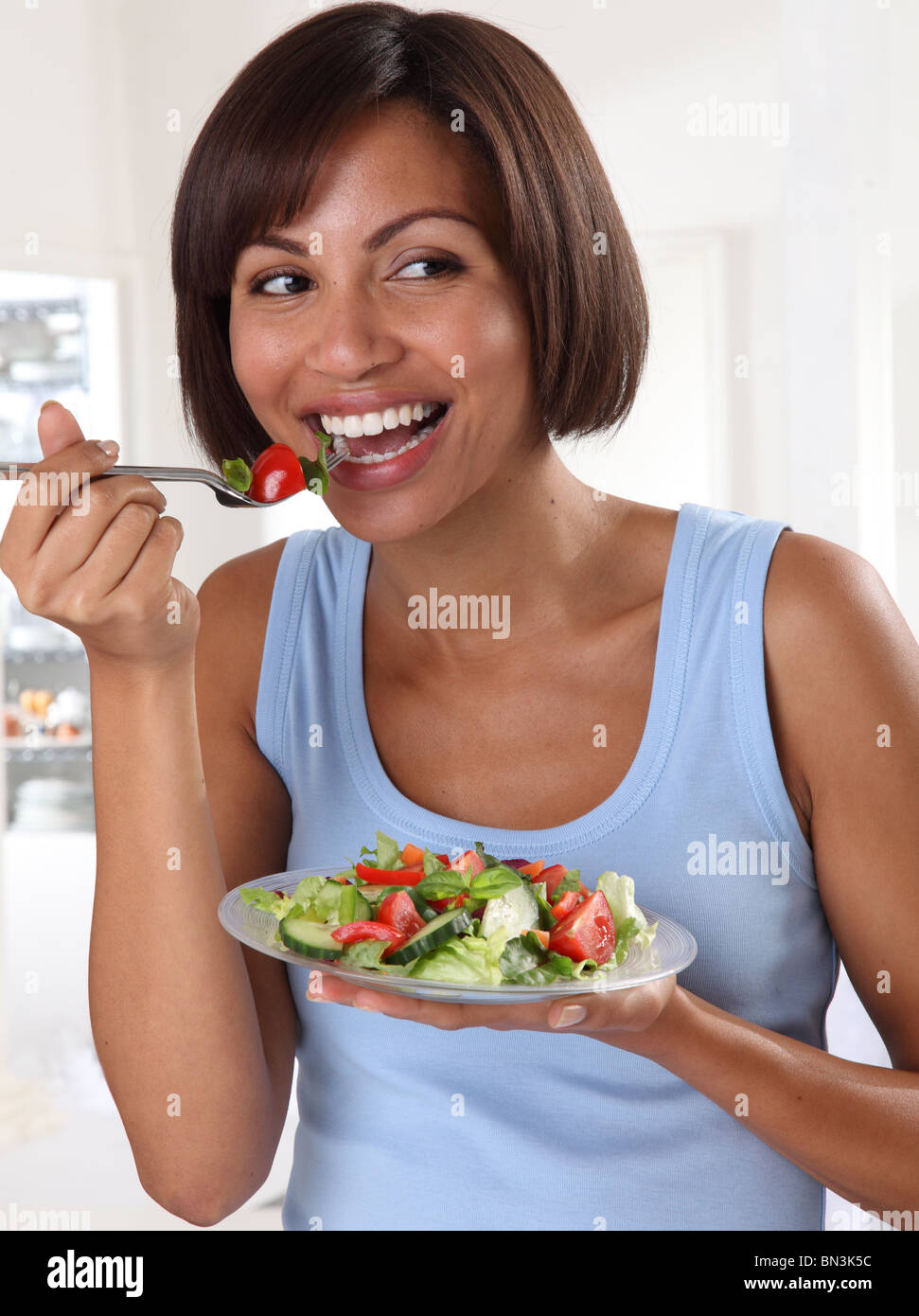 WOMAN EATING MIXED SALAD Stock Photo - Alamy