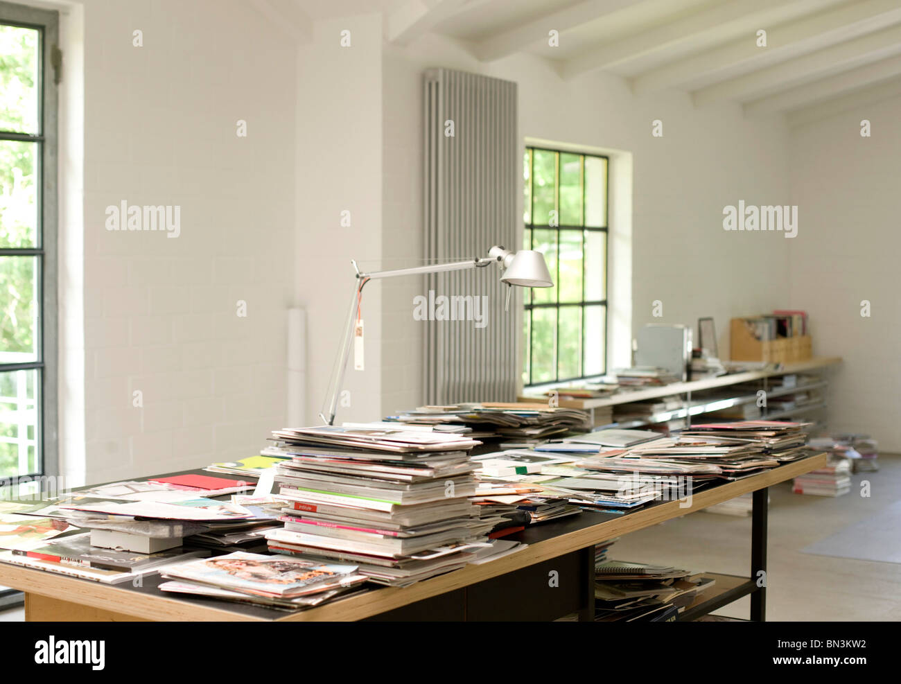 Stacks of magazines and books on a table Stock Photo - Alamy