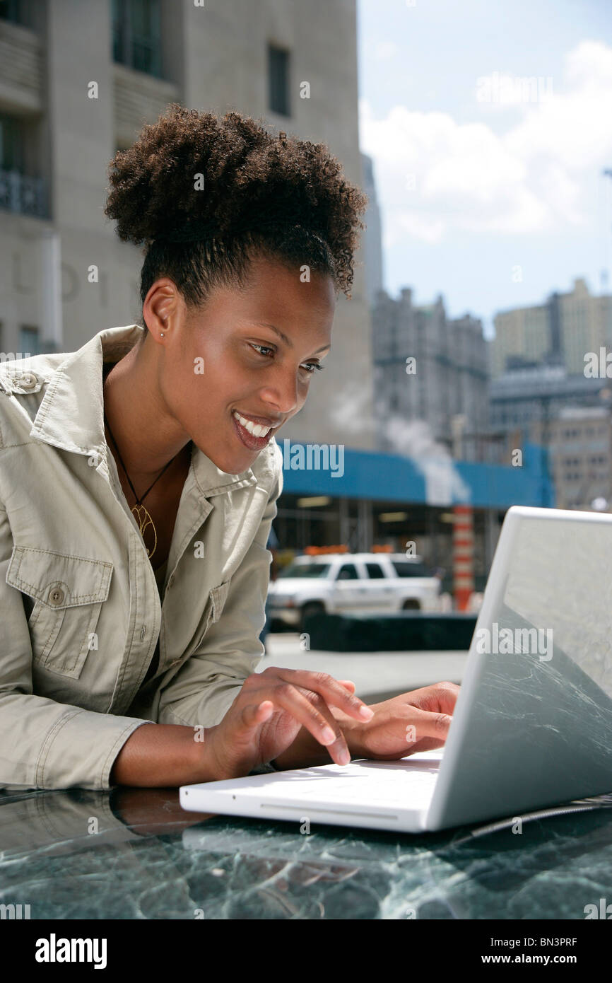 Woman using a notebook Stock Photo - Alamy