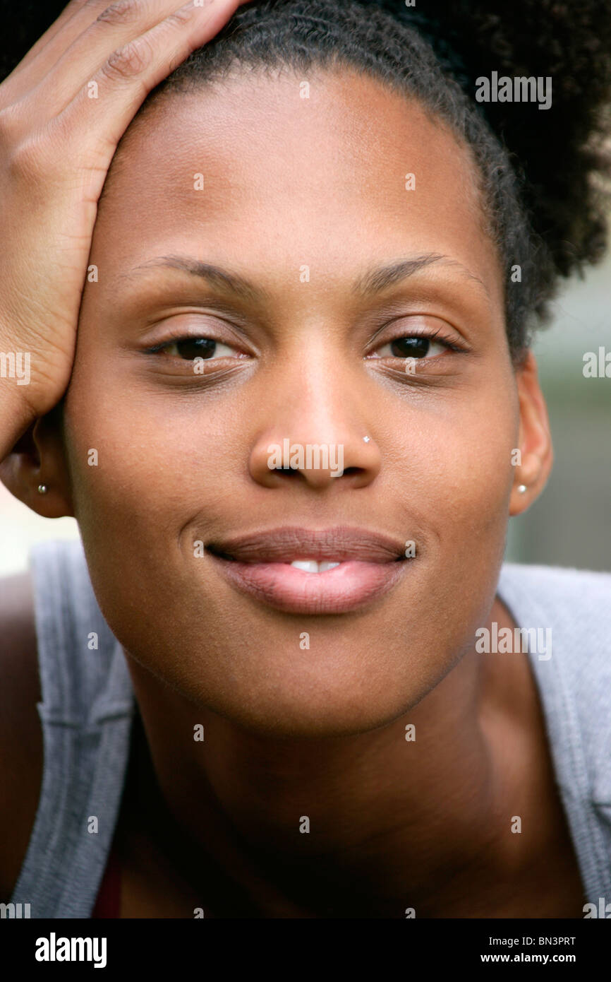 Woman leaning head against her hand, portrait Stock Photo - Alamy