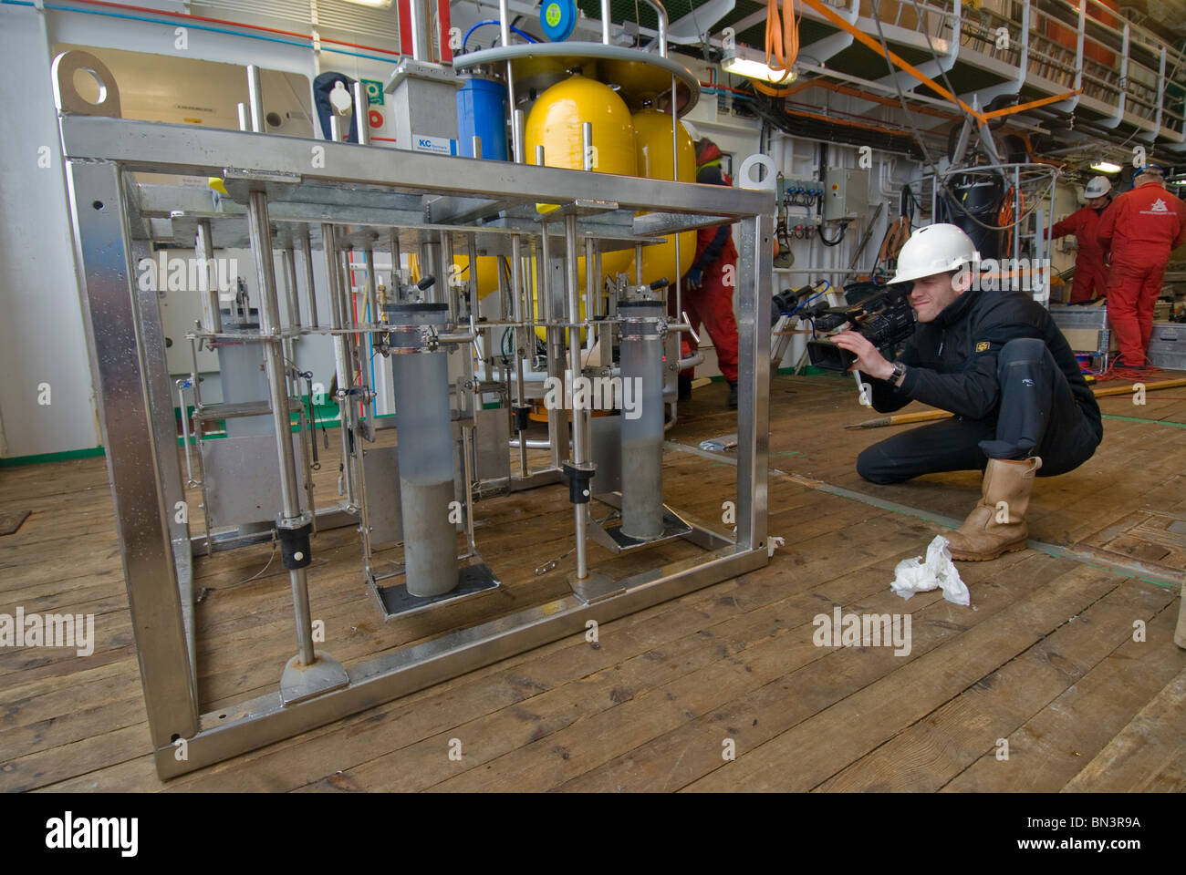 Man filming core samples collected from seabed, South Atlantic Ocean ...