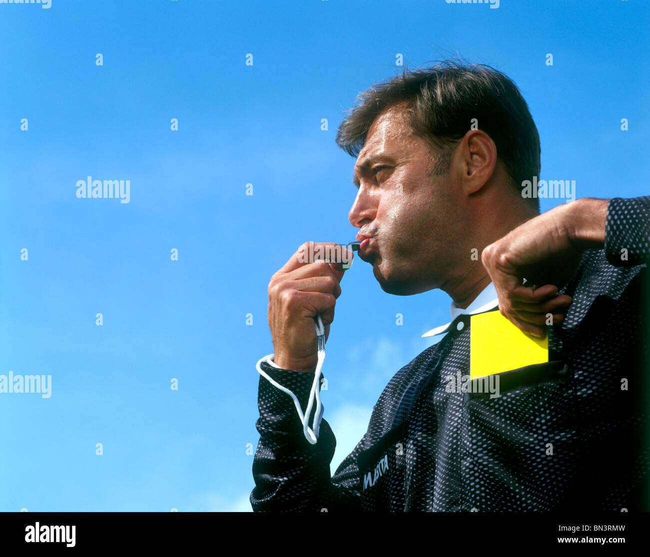 Close-up of referee blowing whistle Stock Photo - Alamy