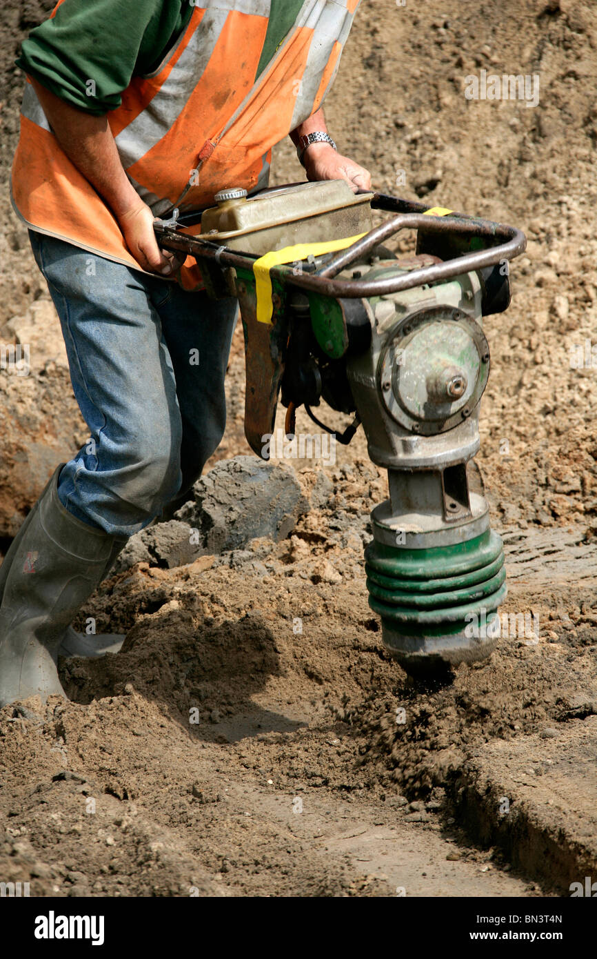 Construction worker using jackhammer Stock Photo - Alamy