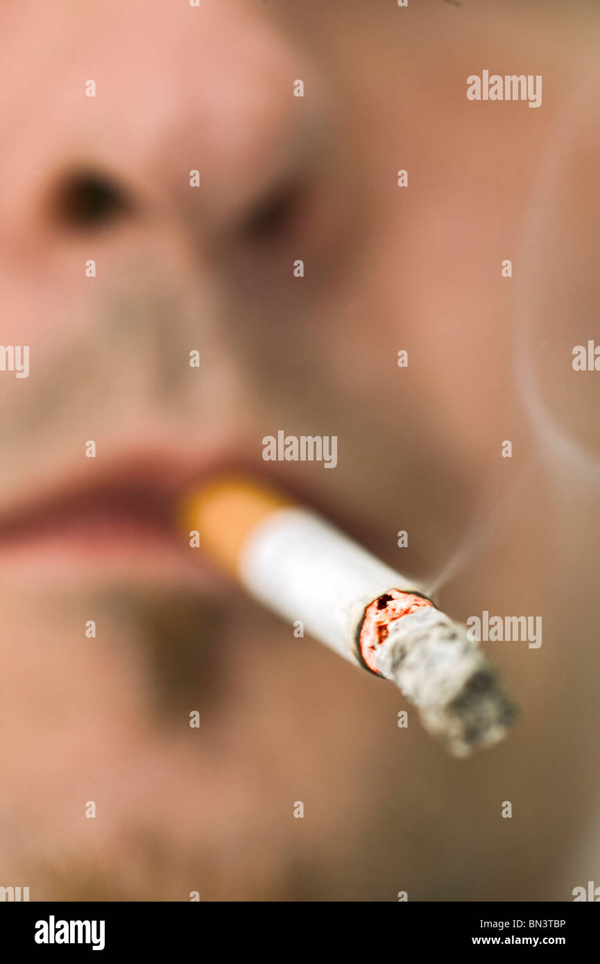 Close-up of man smoking cigarette Stock Photo - Alamy