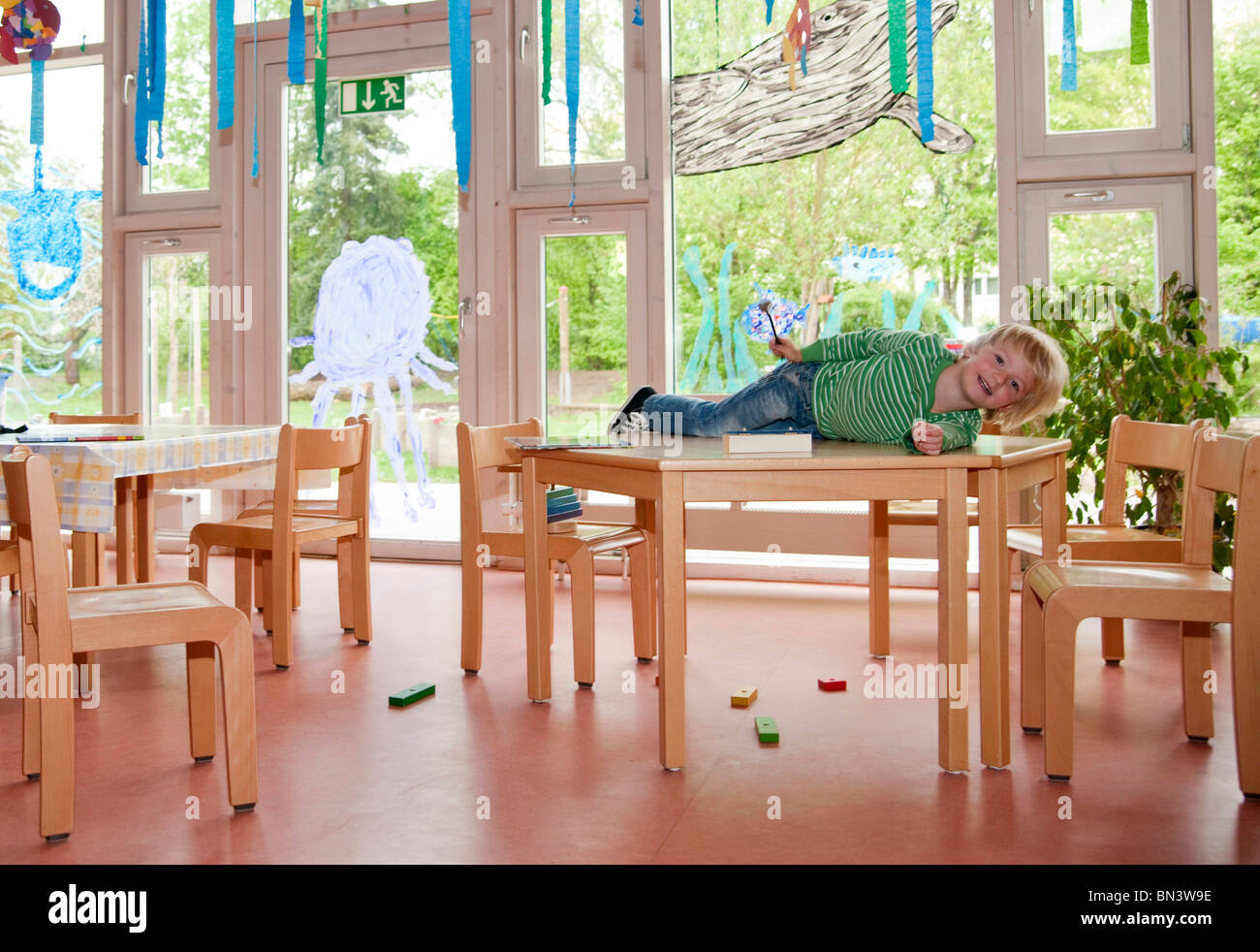 Young boy lying on a table in a kindergarten Stock Photo - Alamy