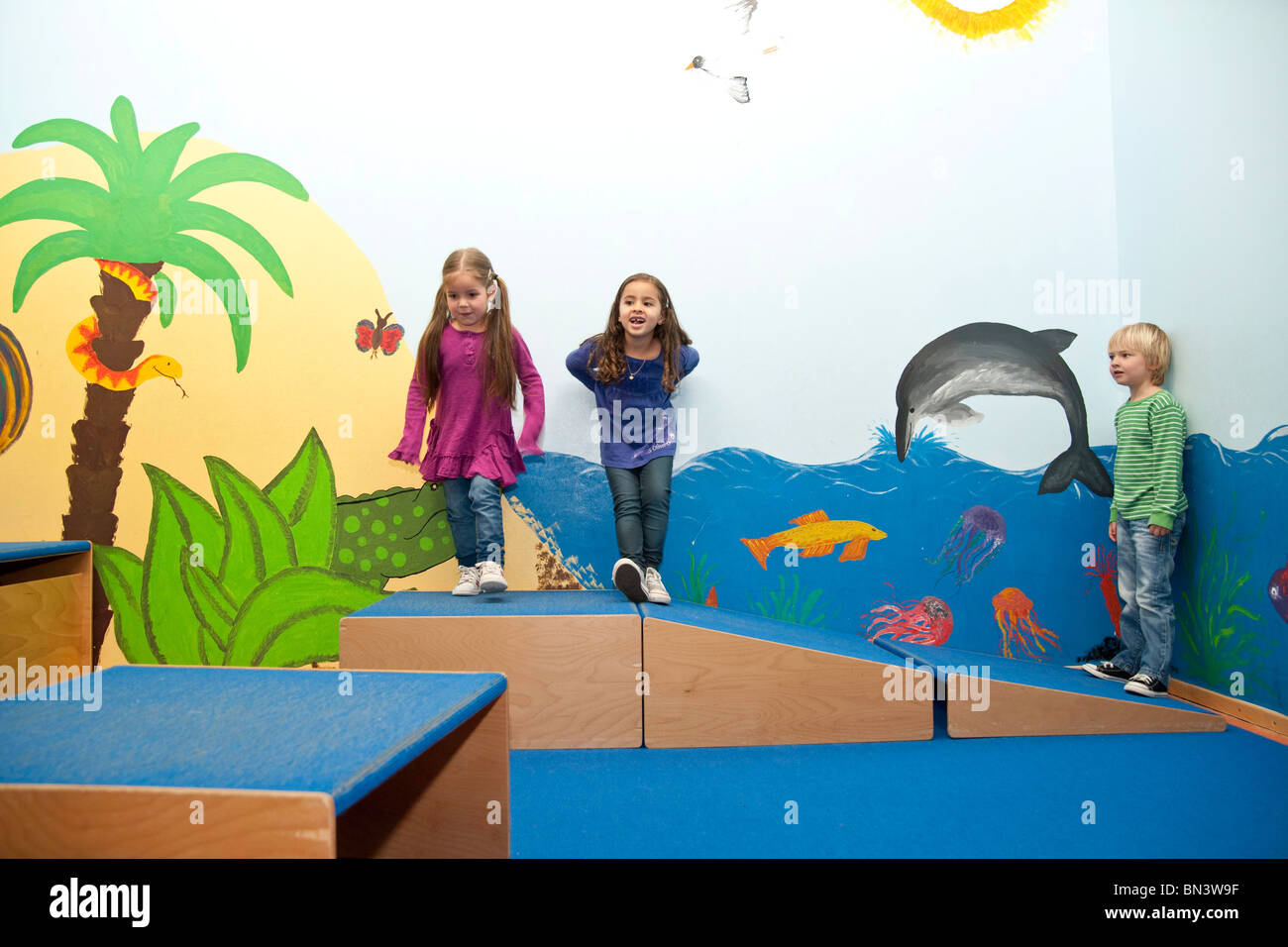 Children standing on boxes in a kindergarten Stock Photo - Alamy