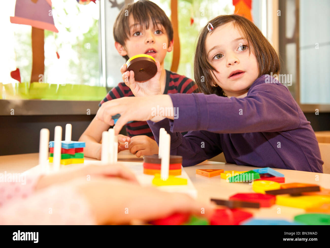Children playing at a table, low angle view Stock Photo - Alamy