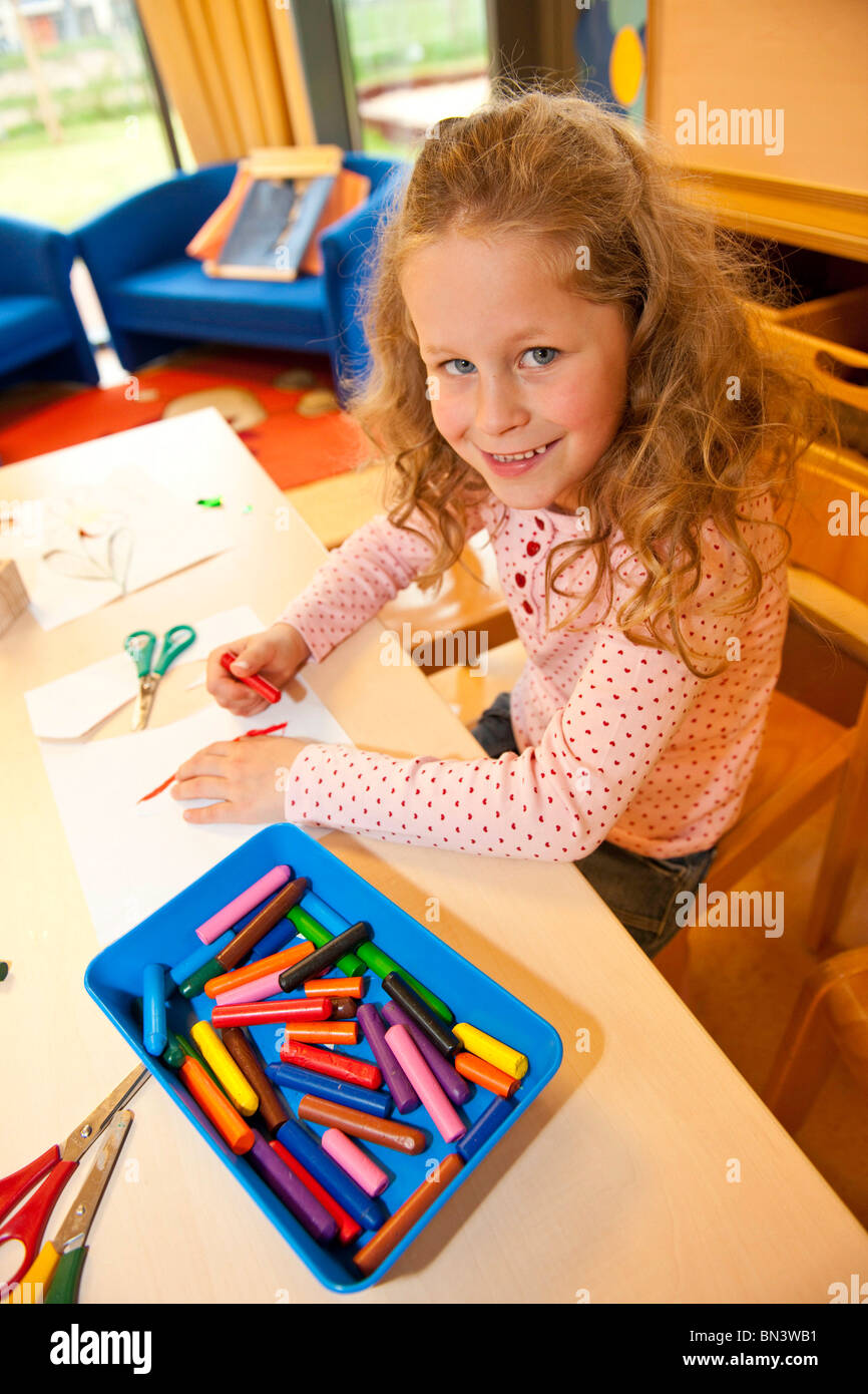 Young girl drawing with wax crayons, elevated view Stock Photo - Alamy