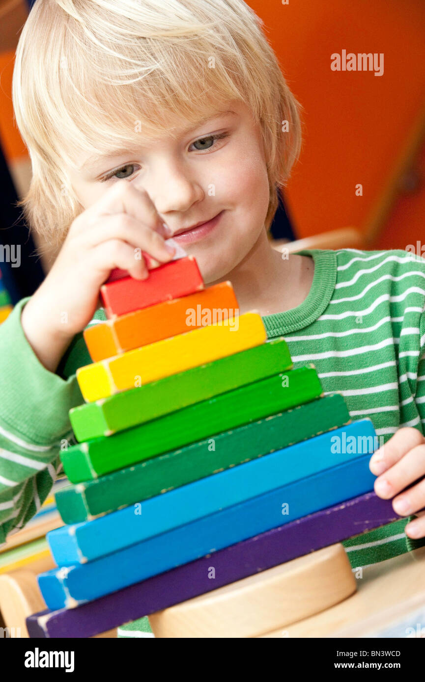 Boy playing building blocks, low angle view Stock Photo - Alamy