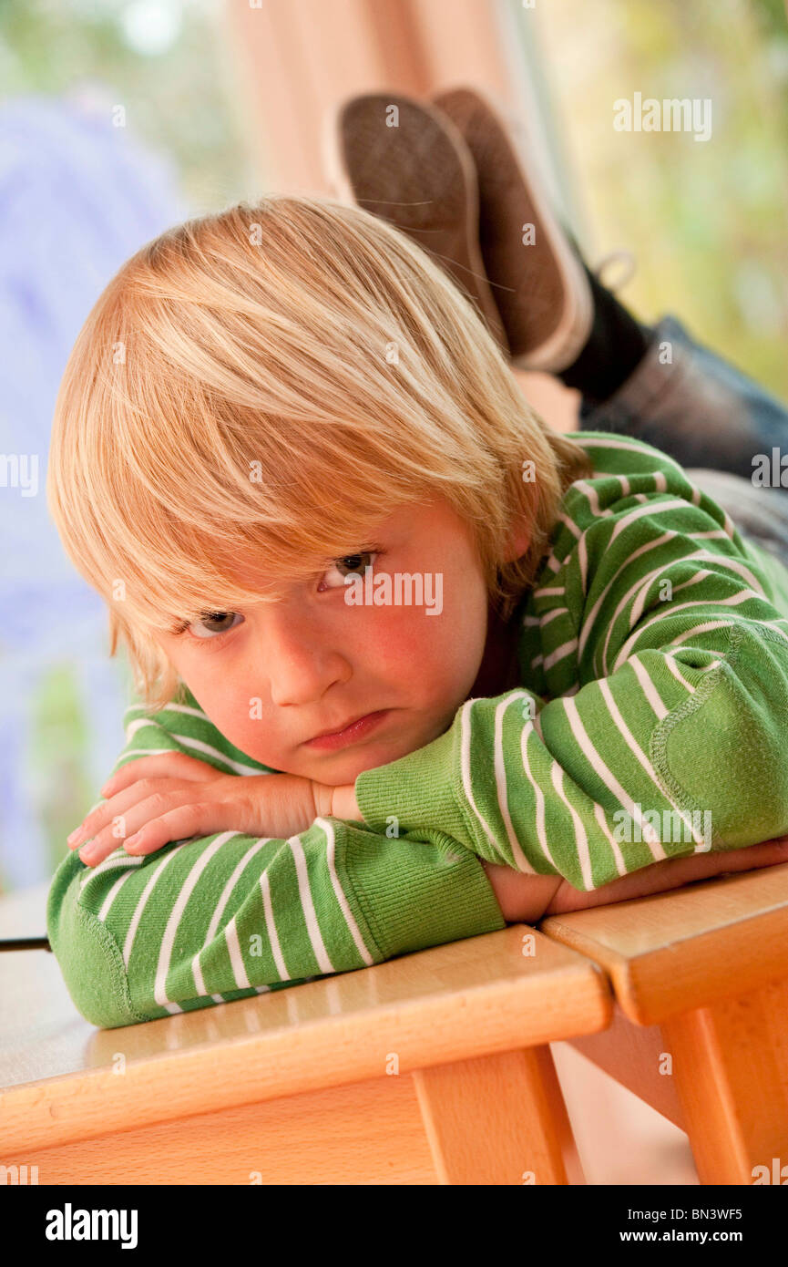 Young boy lying on a table Stock Photo - Alamy