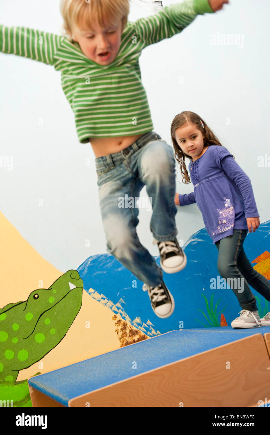 Boy jumping over boxes, low angle view Stock Photo - Alamy