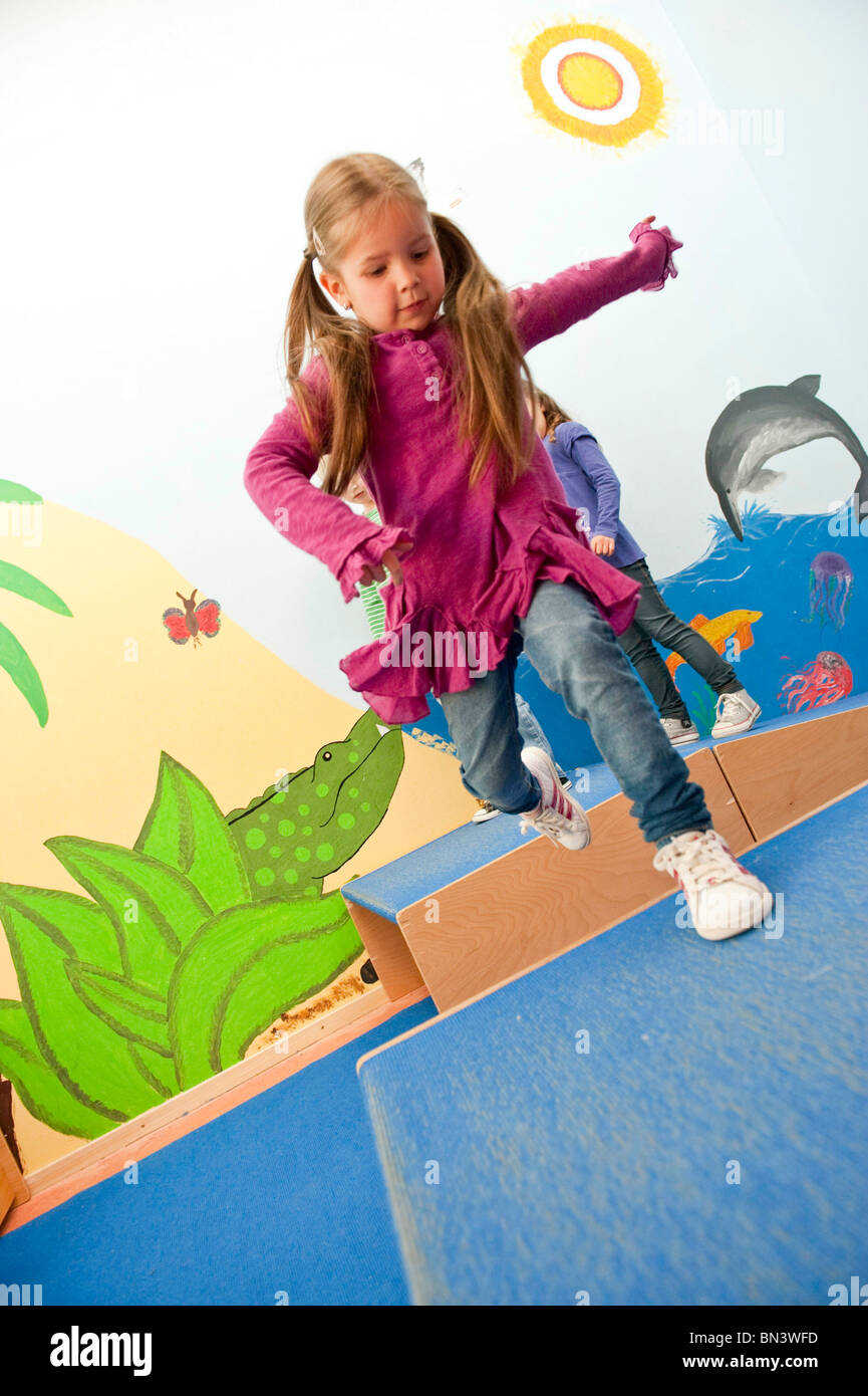Young girl jumping over boxes, low angle view Stock Photo - Alamy