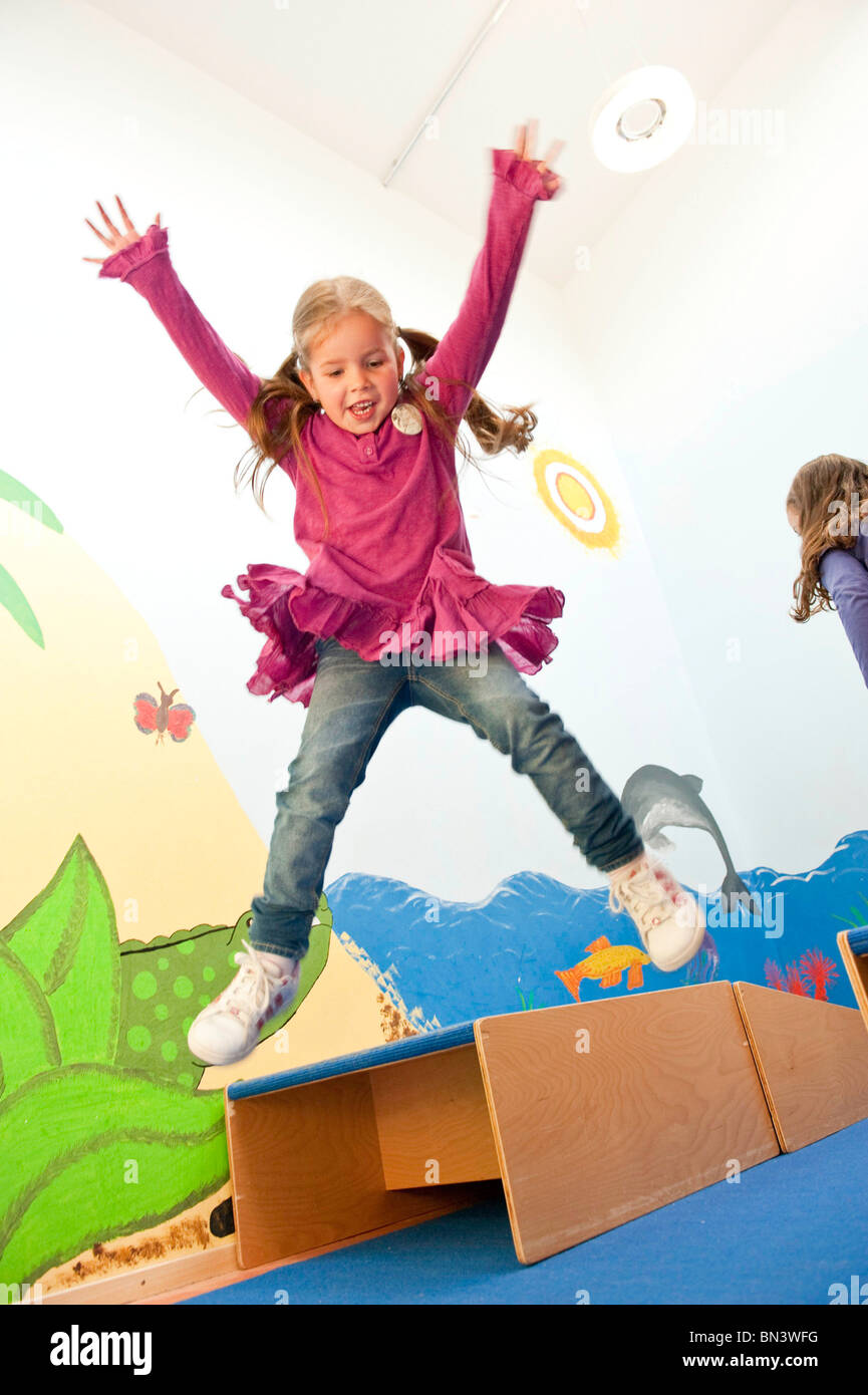 Children jumping over boxes, low angle view Stock Photo - Alamy