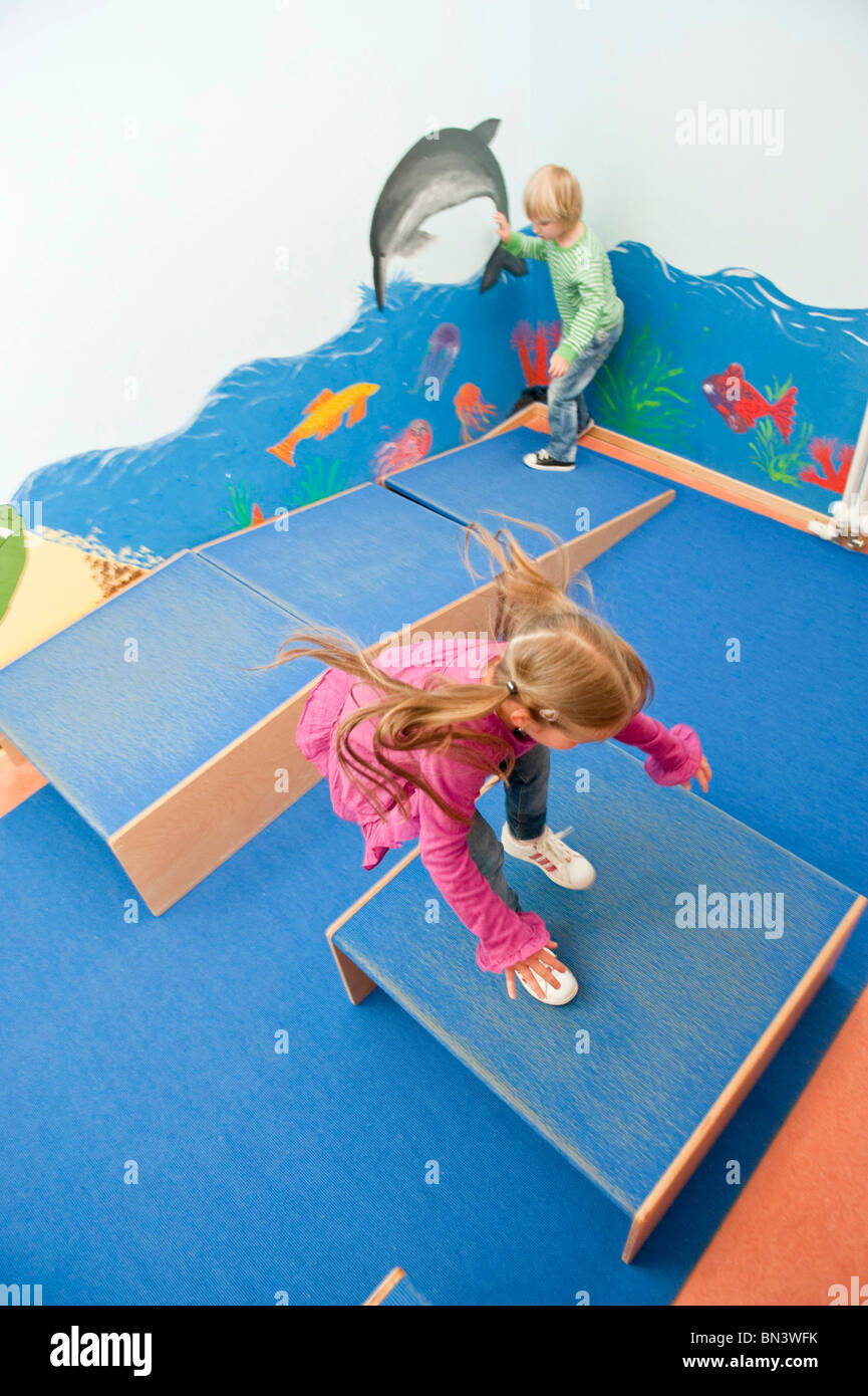 Children jumping over boxes, elevated view Stock Photo - Alamy