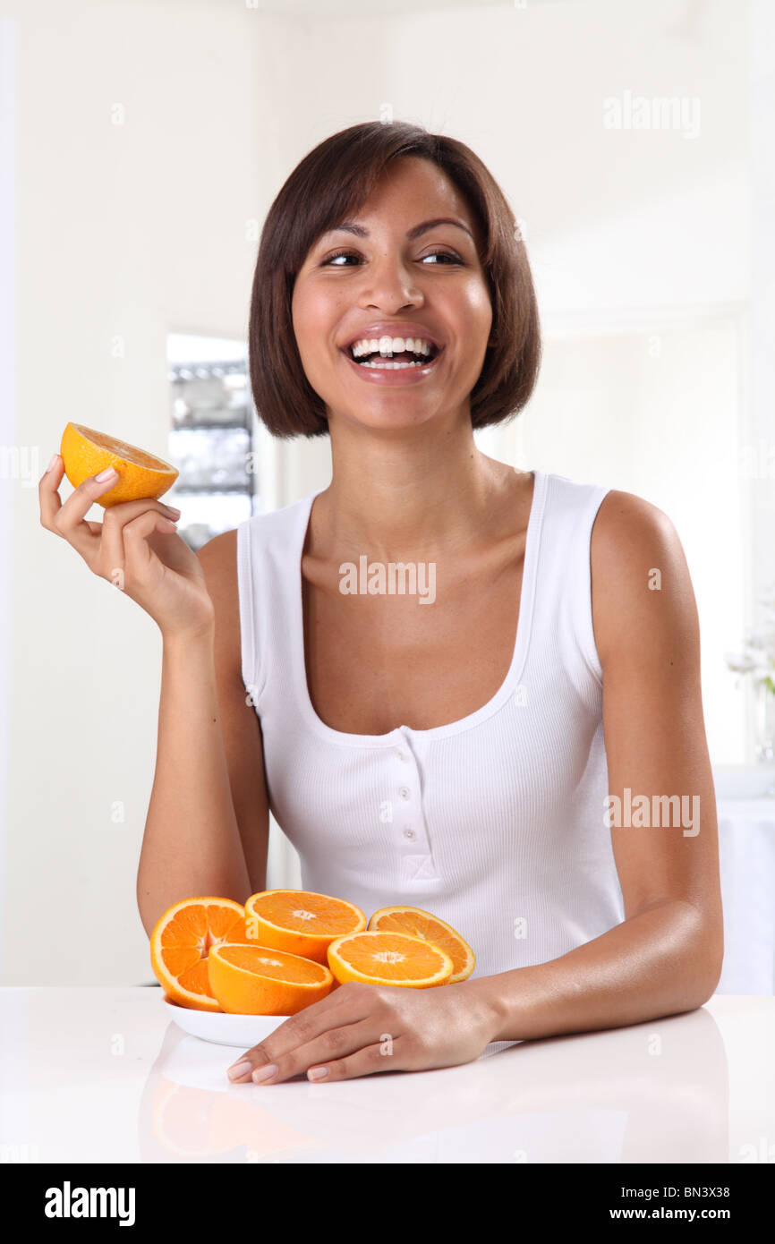 WOMAN EATING ORANGES Stock Photo - Alamy