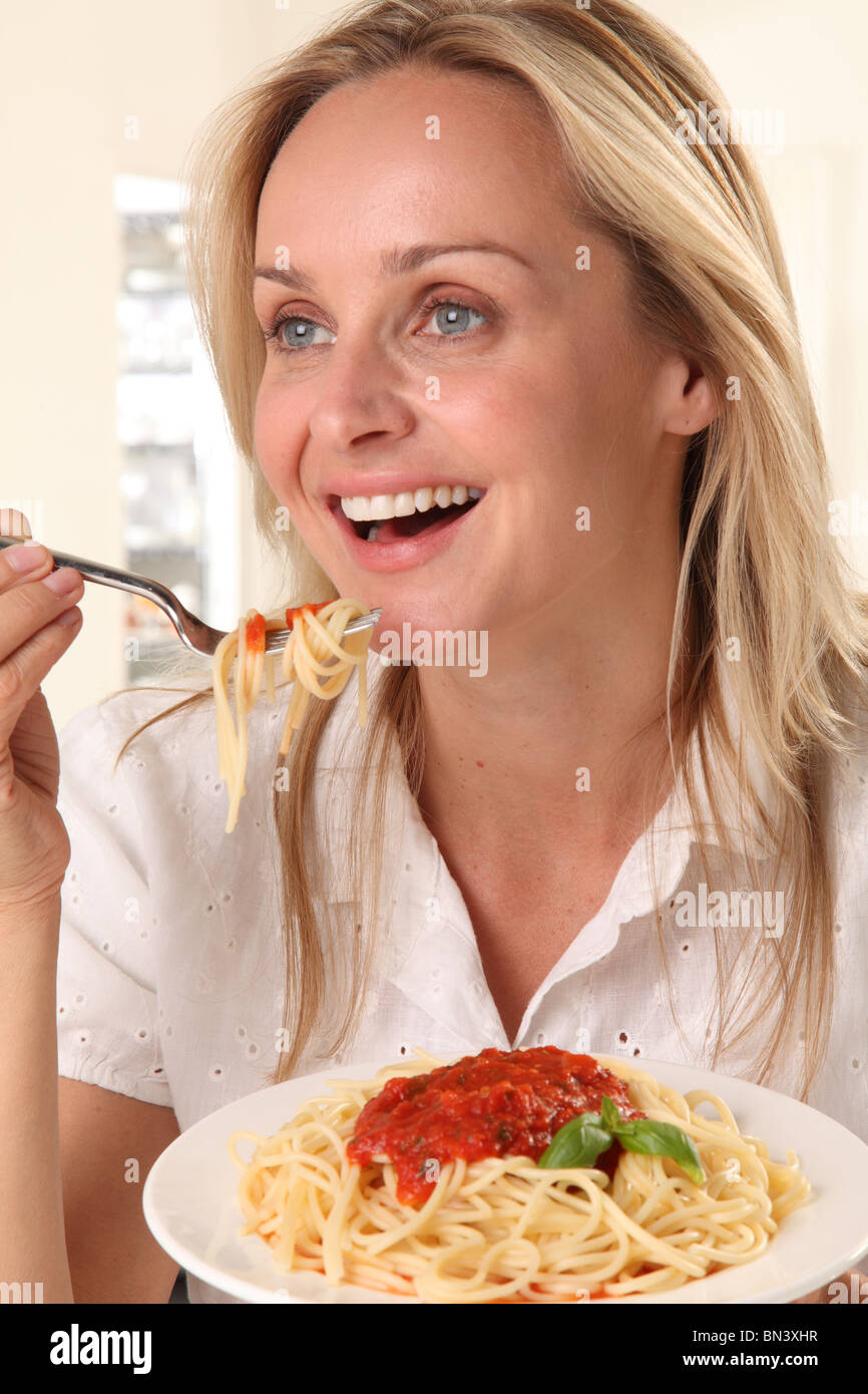 WOMAN EATING PASTA Stock Photo - Alamy
