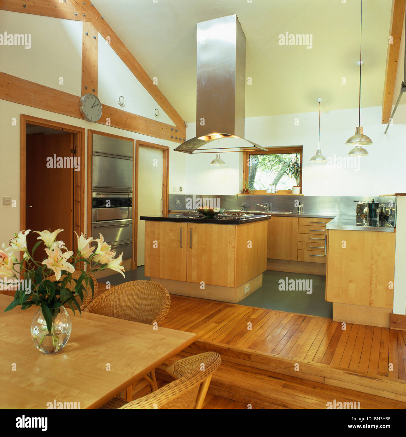 Large stainless steel extractor above island unit in modern barn ...