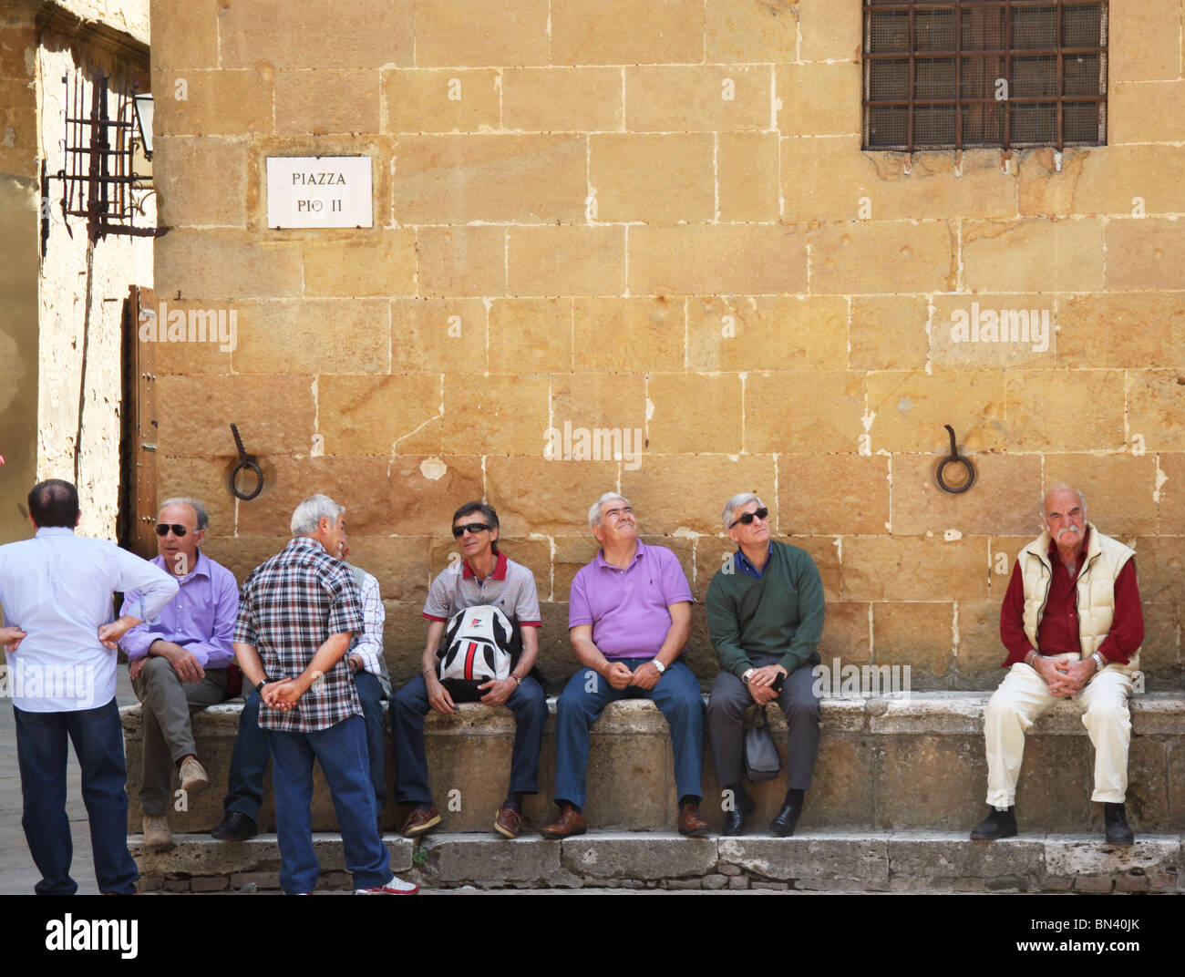 A gathering of men in the Piazza Pio II, Pienza, Tuscany, Italy Stock ...