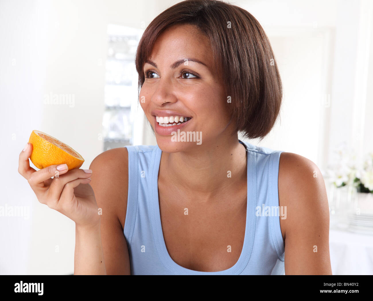 WOMAN EATING ORANGE Stock Photo - Alamy