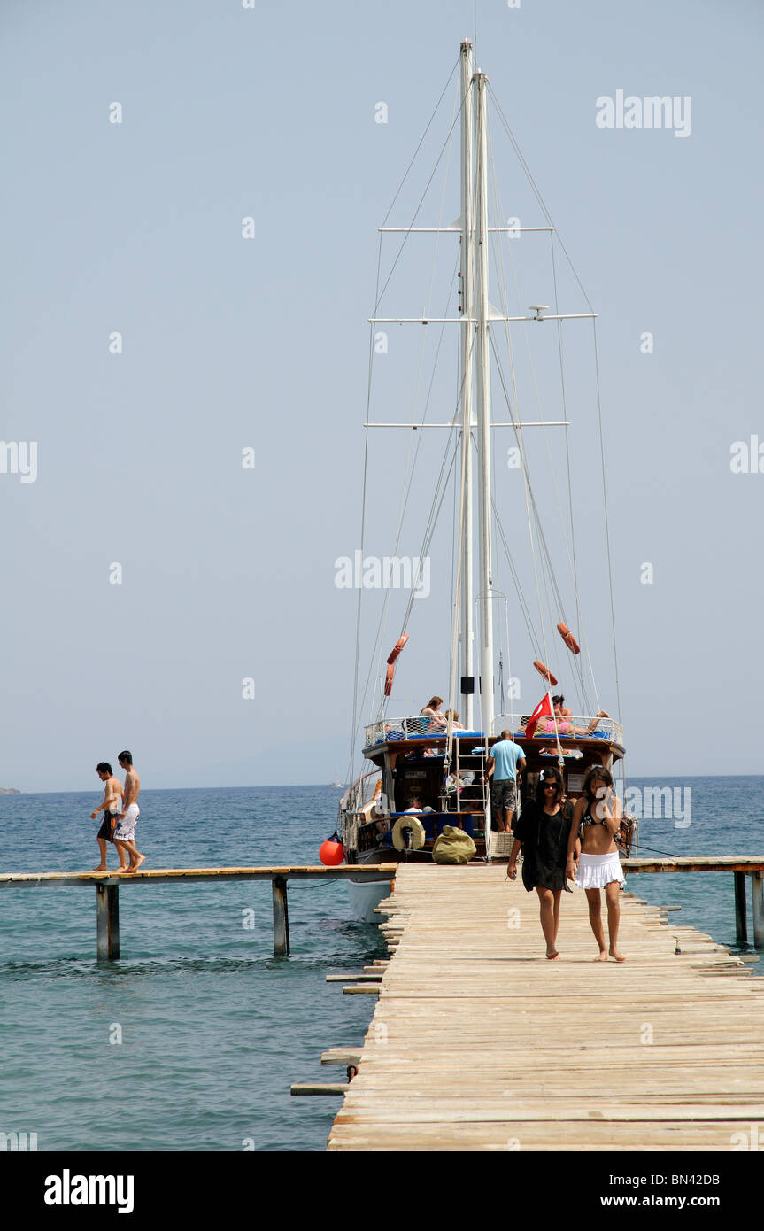 Holidaymakers arriving on Camel Beach Bodrum SW Turkey from their ...
