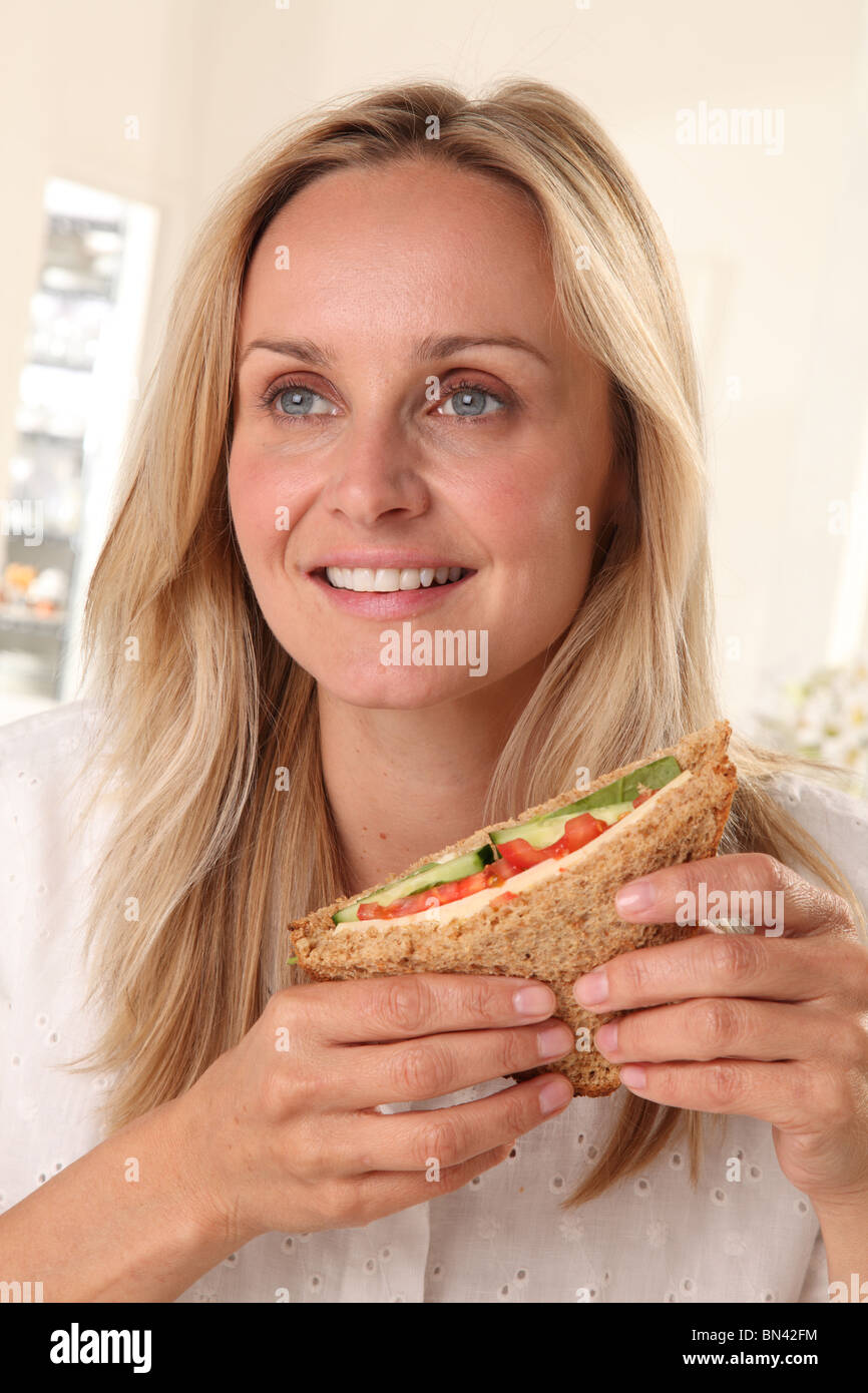 WOMAN EATING A SANDWICH Stock Photo - Alamy