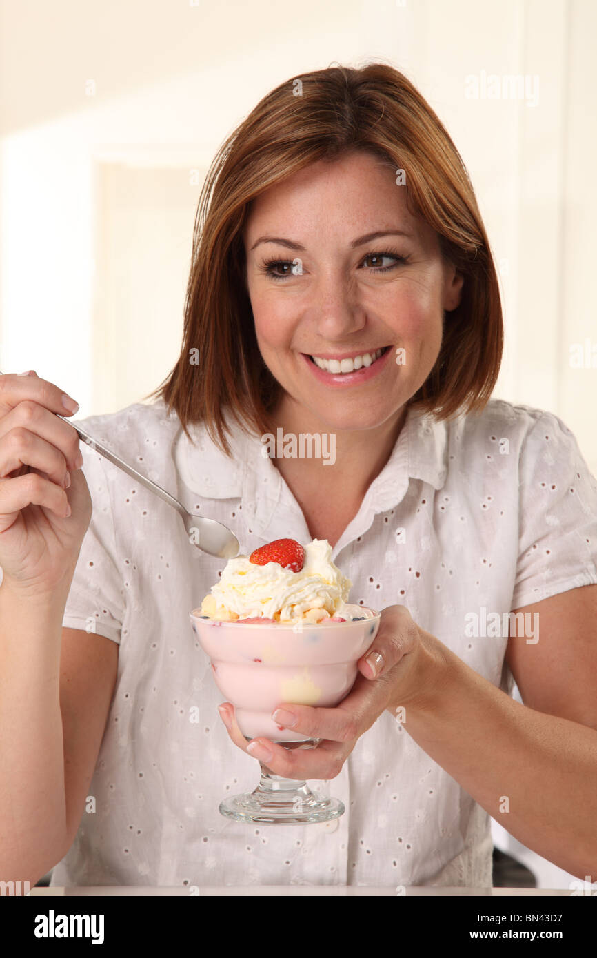 WOMAN EATING ICE CREAM SUNDAE Stock Photo - Alamy