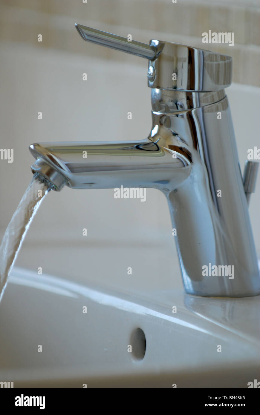 A running tap in a modern bathroom Stock Photo - Alamy