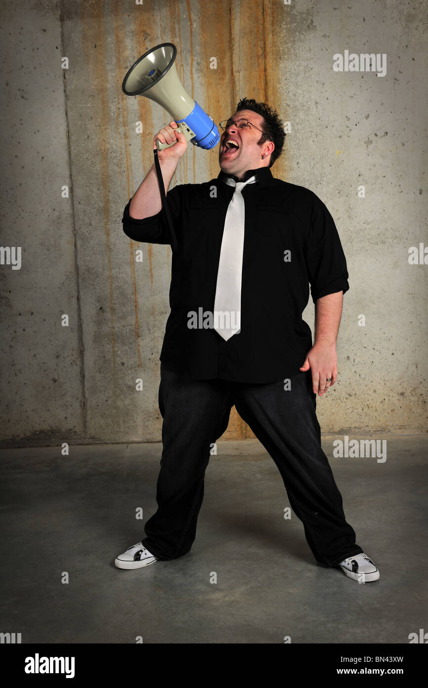 Man using megaphone over grunge industrial environment Stock Photo - Alamy