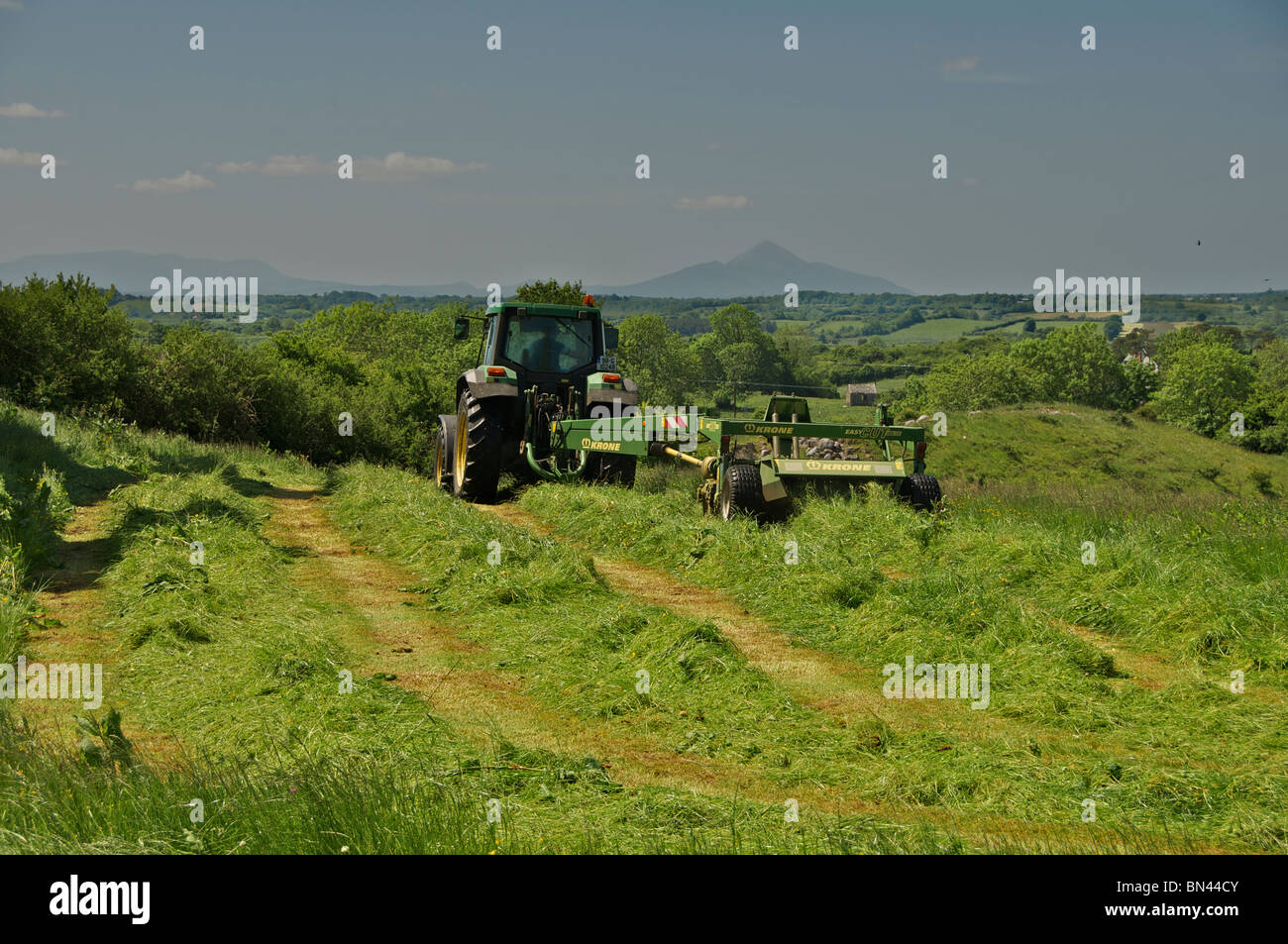 A farmer cutting hay in the west of Ireland Stock Photo - Alamy